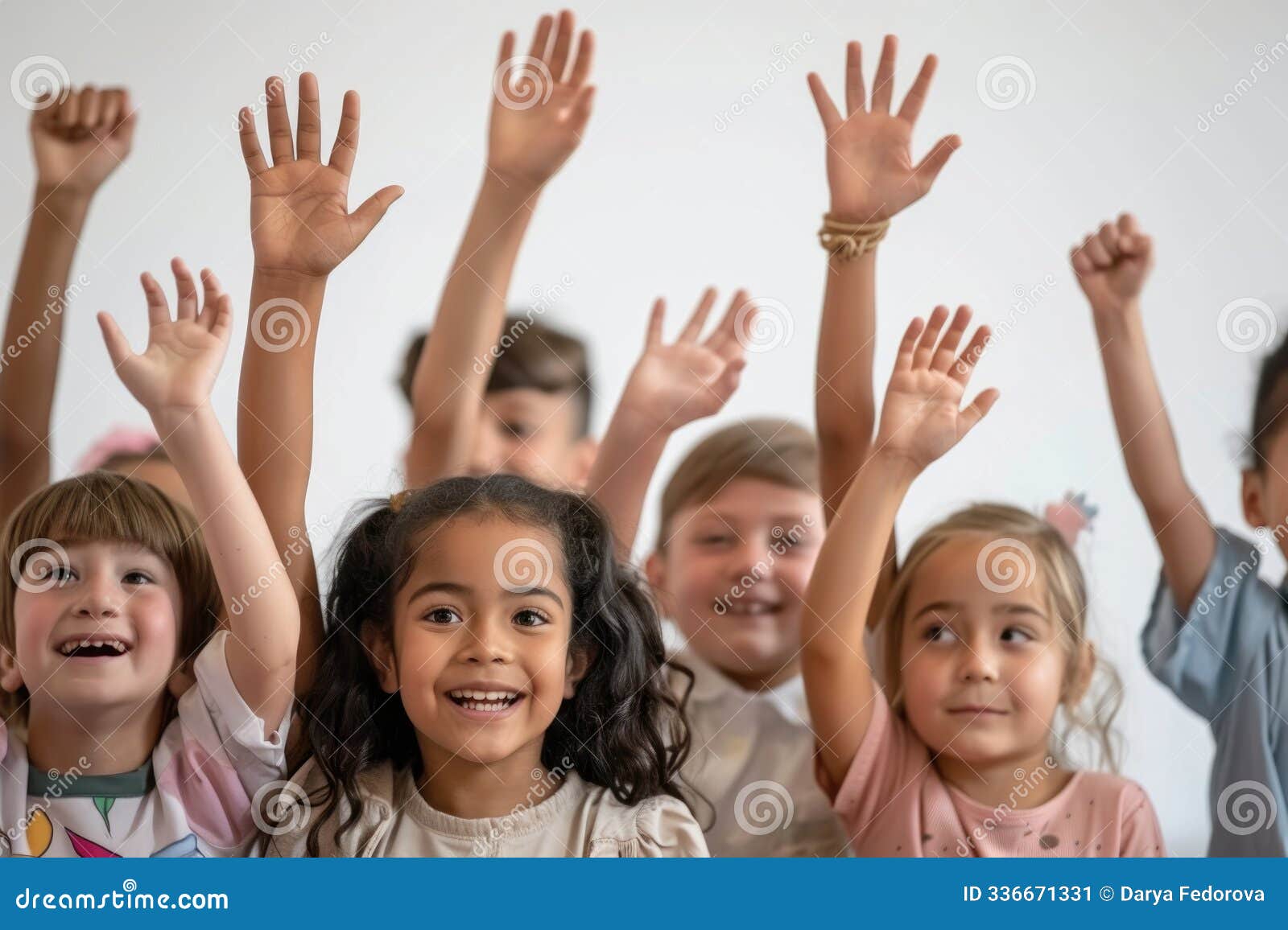 Group of Diverse Children Raising Hands in Classroom Setting for ...