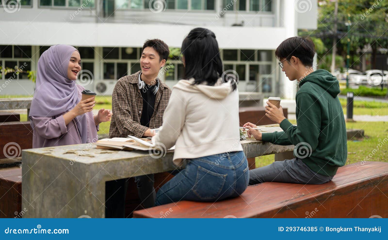 A Group of Diverse College Students is Discussing and Working on a ...