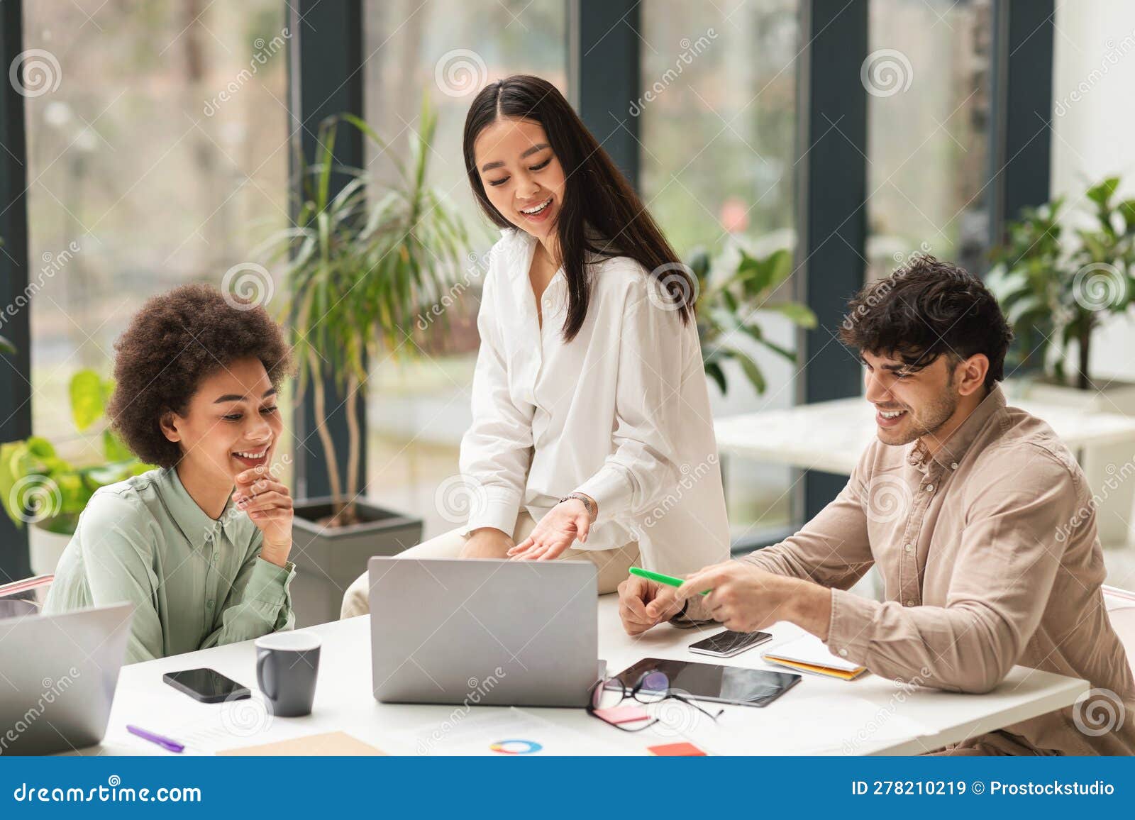 Group of Diverse Coworkers Using Laptop Discussing Project in Office ...