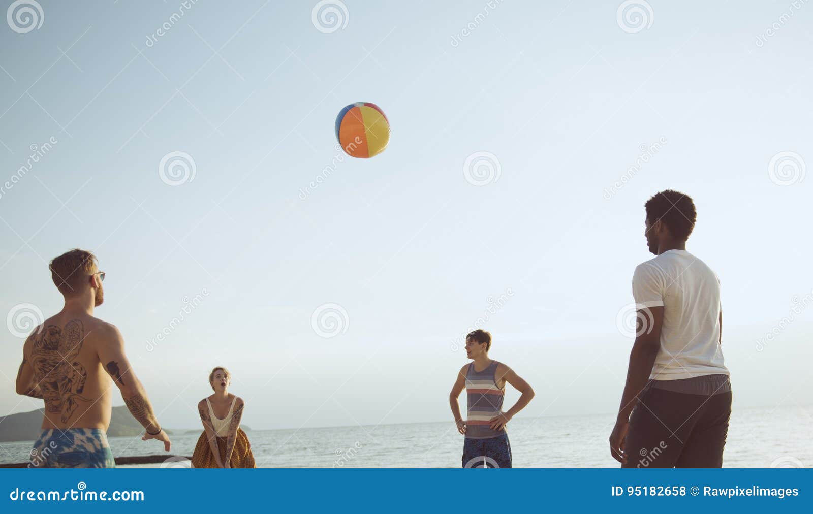 Group of Diverse Friends Playing Beach Ball Together Stock Photo ...