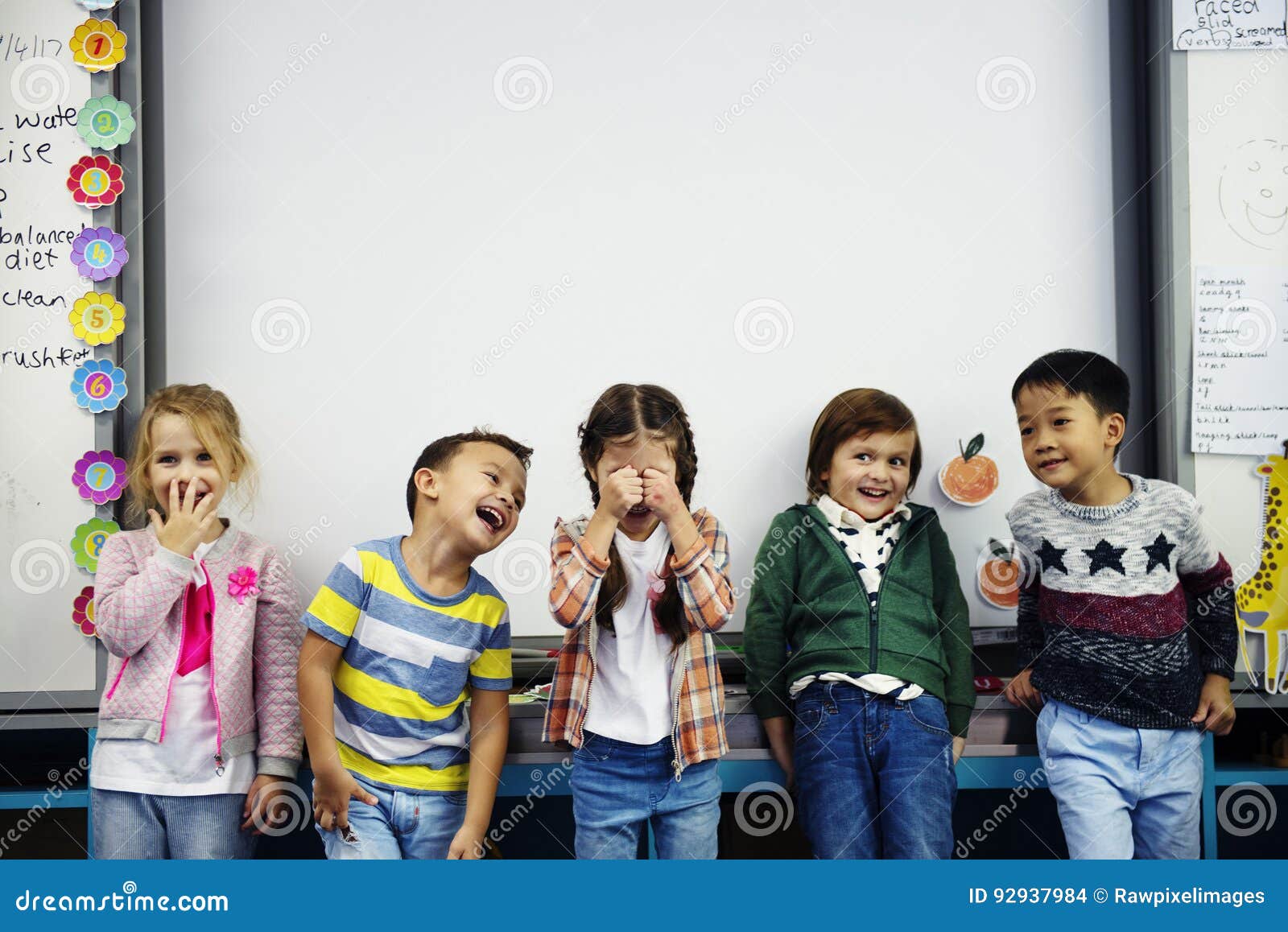 Group of Diverse Kindergarten Students Standing Together in Classroom ...