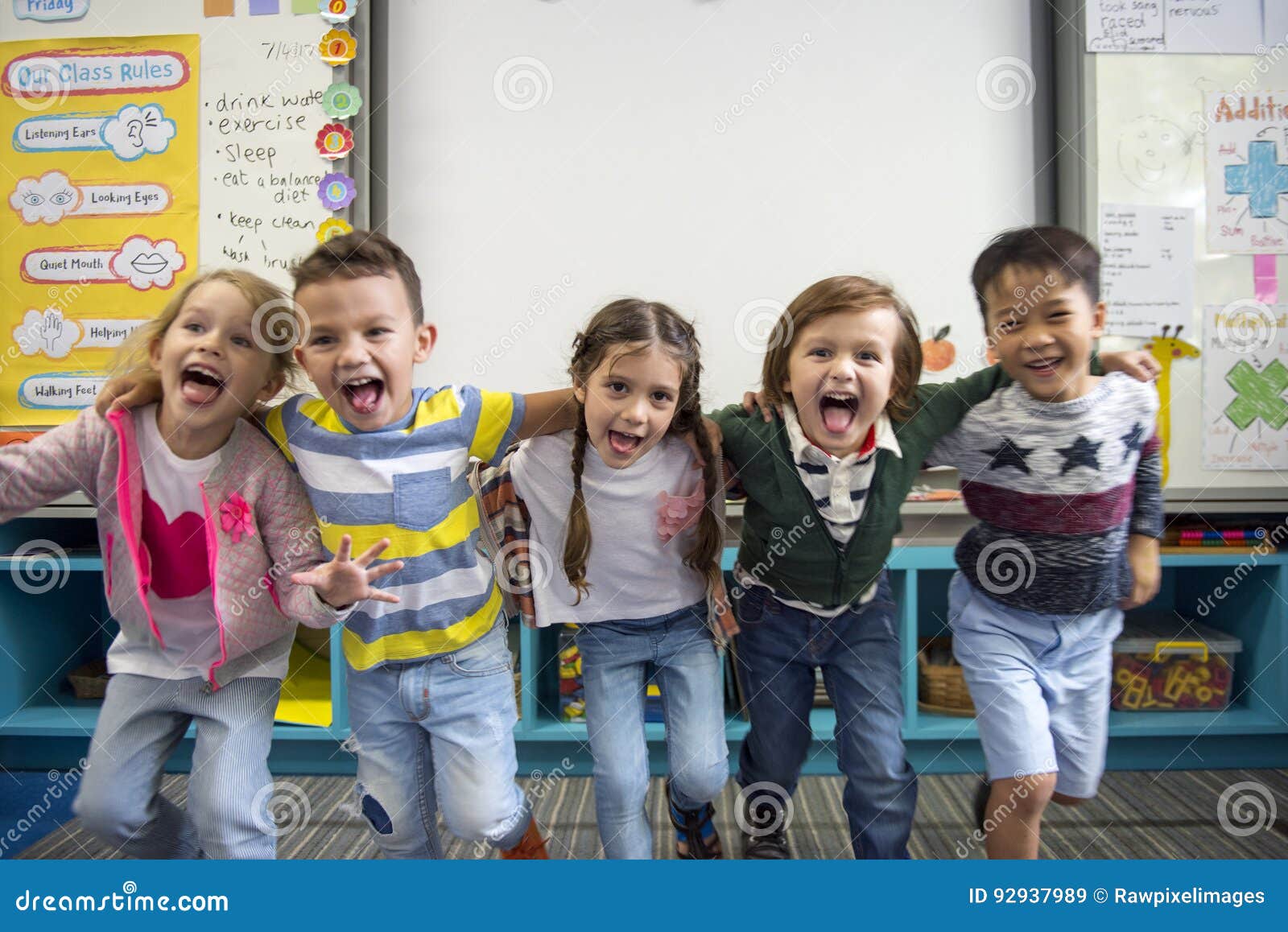 Group of Diverse Kindergarten Students Standing Together in Classroom ...