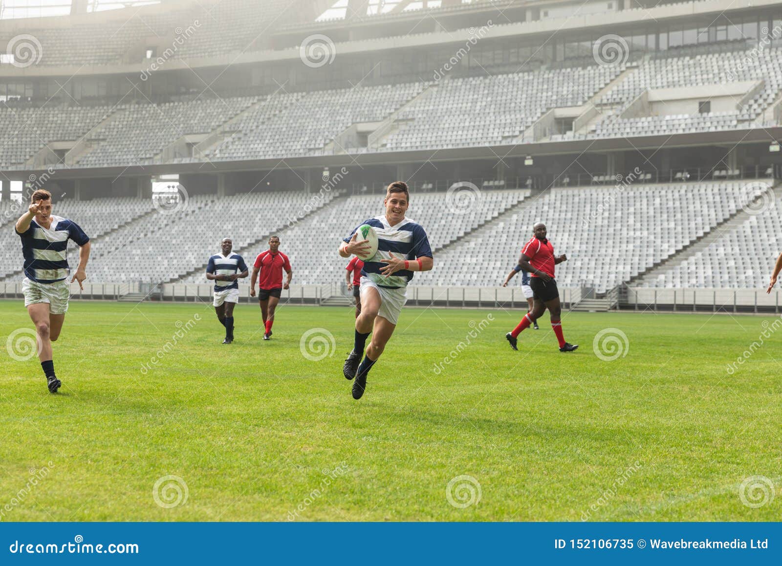 Group of Diverse Male Rugby Players Playing Rugby in Stadium Stock ...