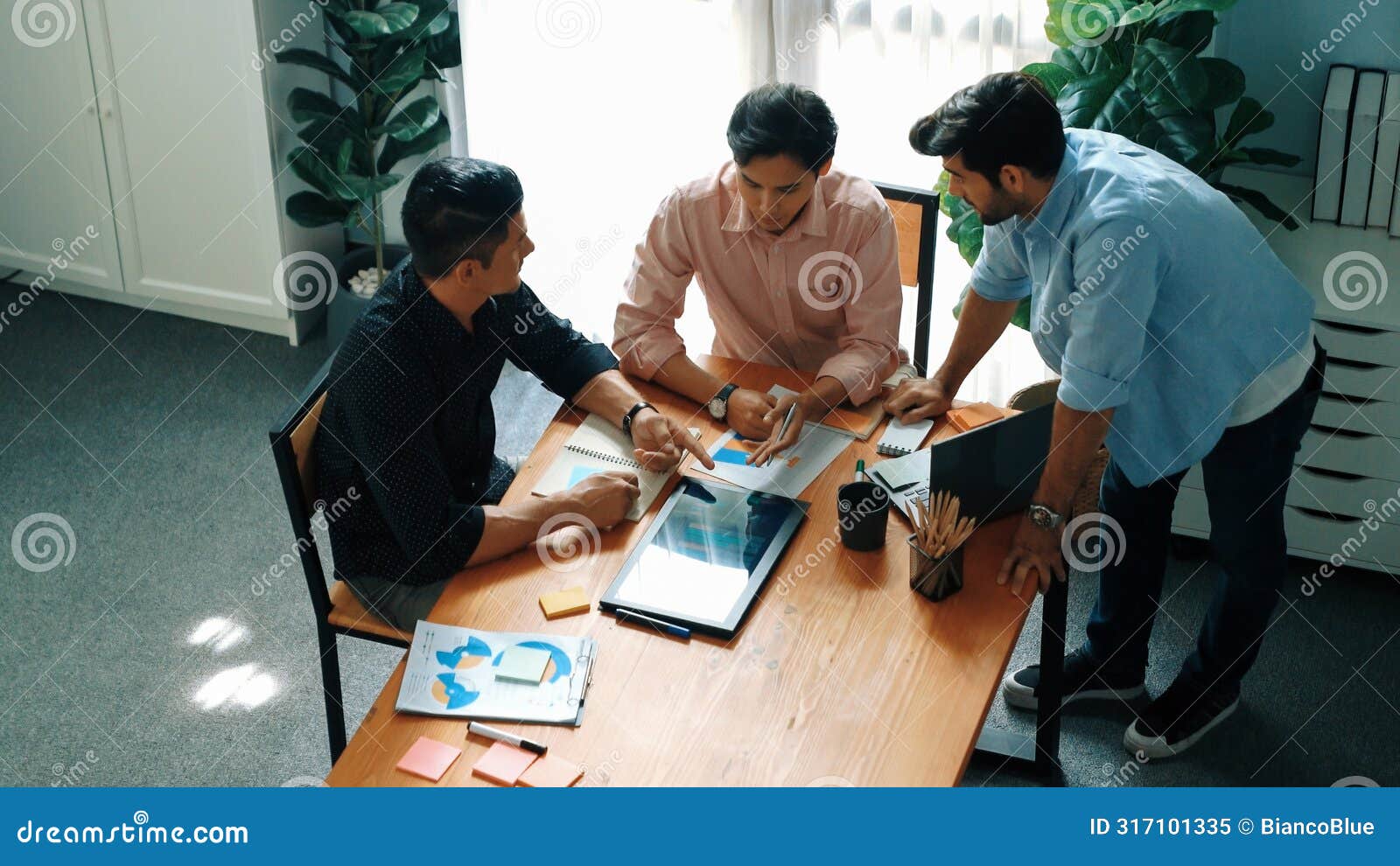 Group of Diverse People Sharing Idea while Writing at Sticky Notes ...
