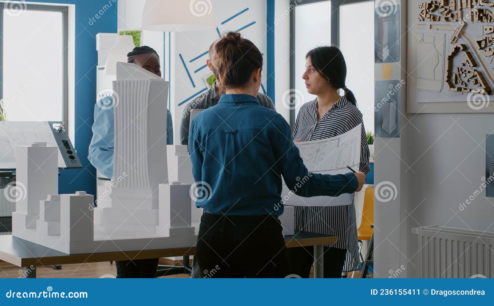 Group of Diverse People Working on Design of Building Model with Laptop ...