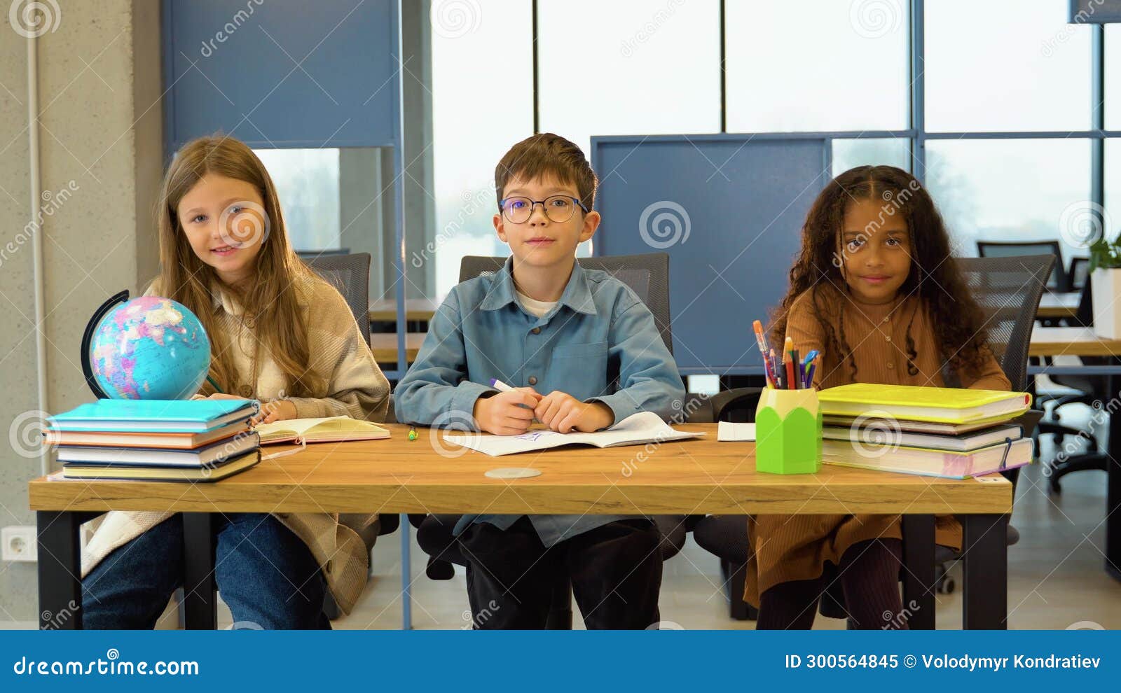 Group of Diverse Pupils Posing and Looking at Camera in Classroom Stock ...