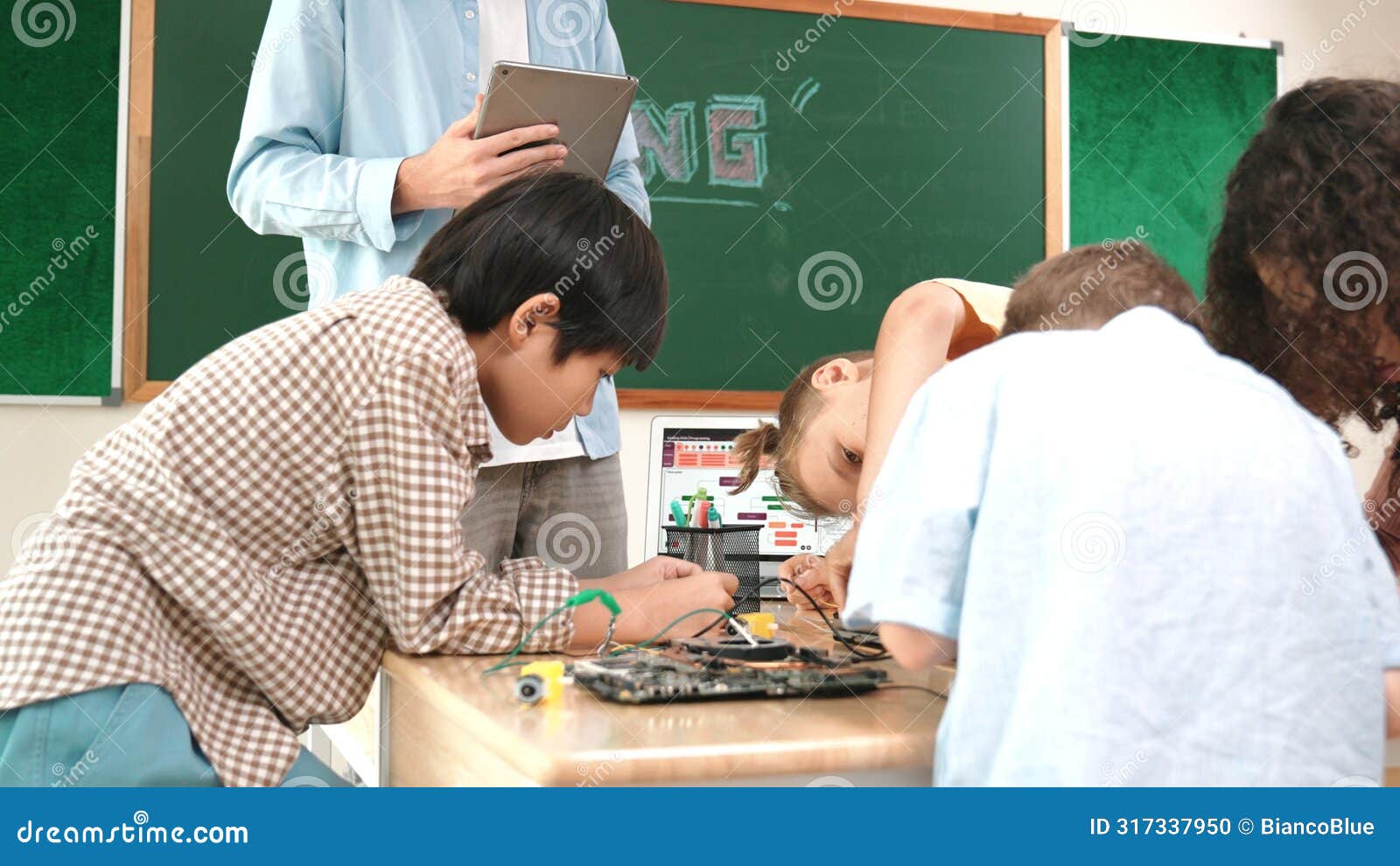 Group of Diverse Student Working Together while Teacher Hold Tablet ...