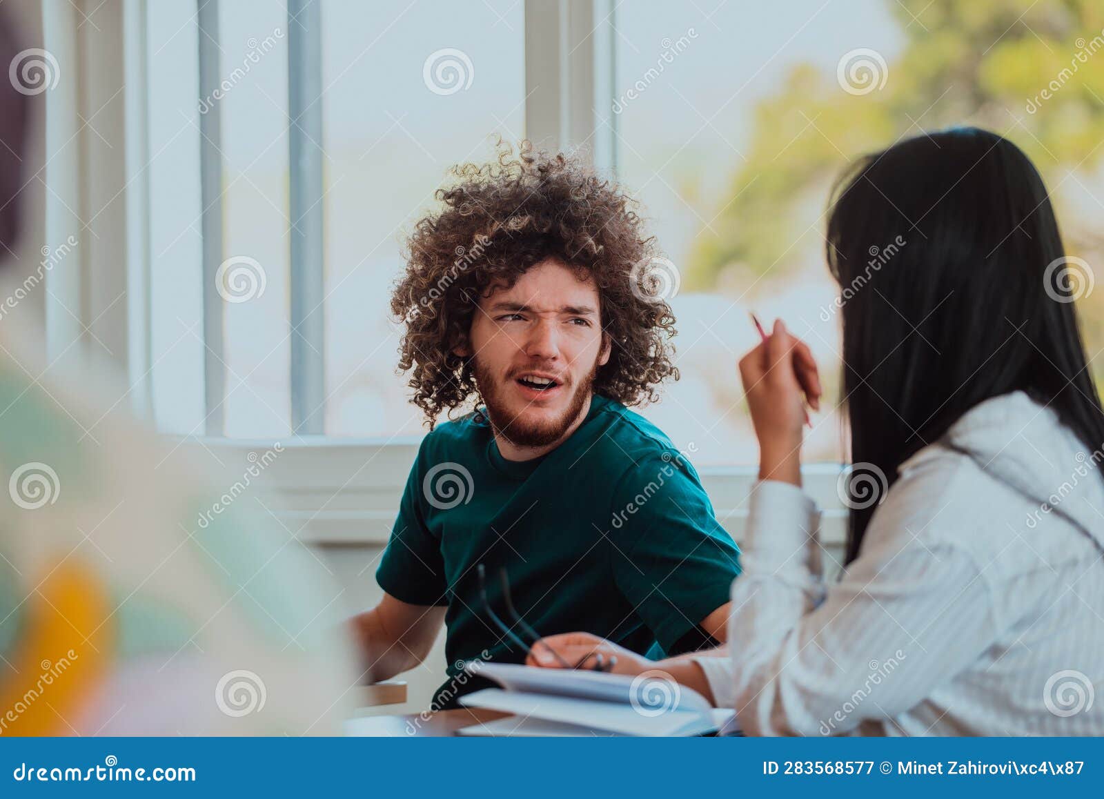 A Group of Diverse Students Engages in Lively Discussion As they ...