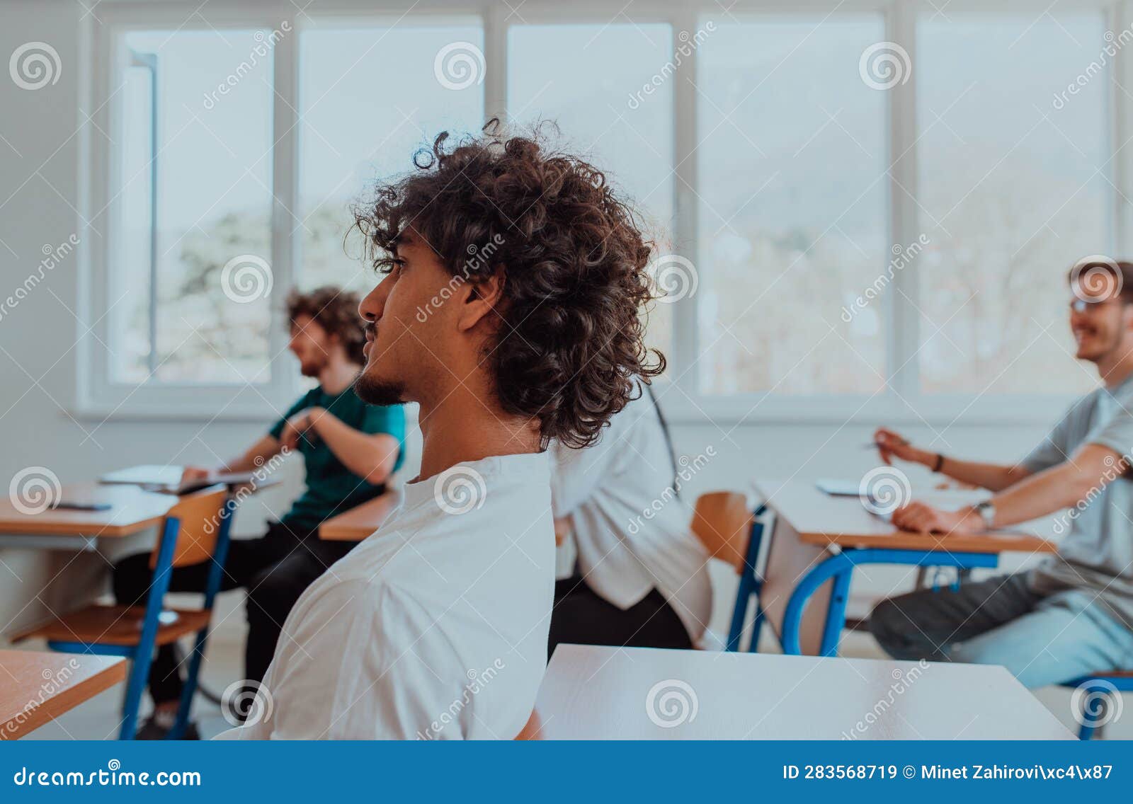 A Group of Diverse Students Engages in Lively Discussion As they ...