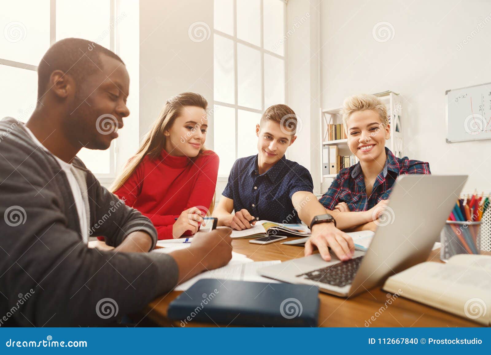 Group of Diverse Students Studying at Wooden Table Stock Photo - Image ...