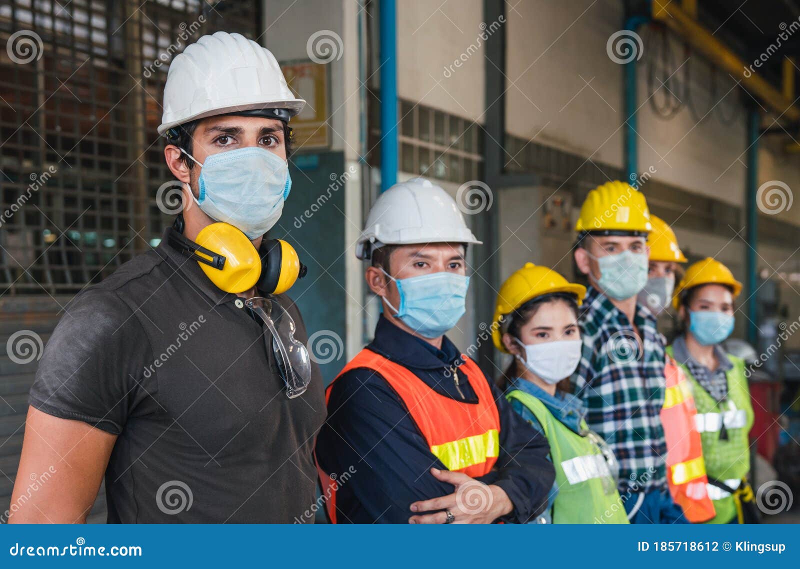 Group of Diverse Team of Workers Wearing Face Mask Standing in Front of ...