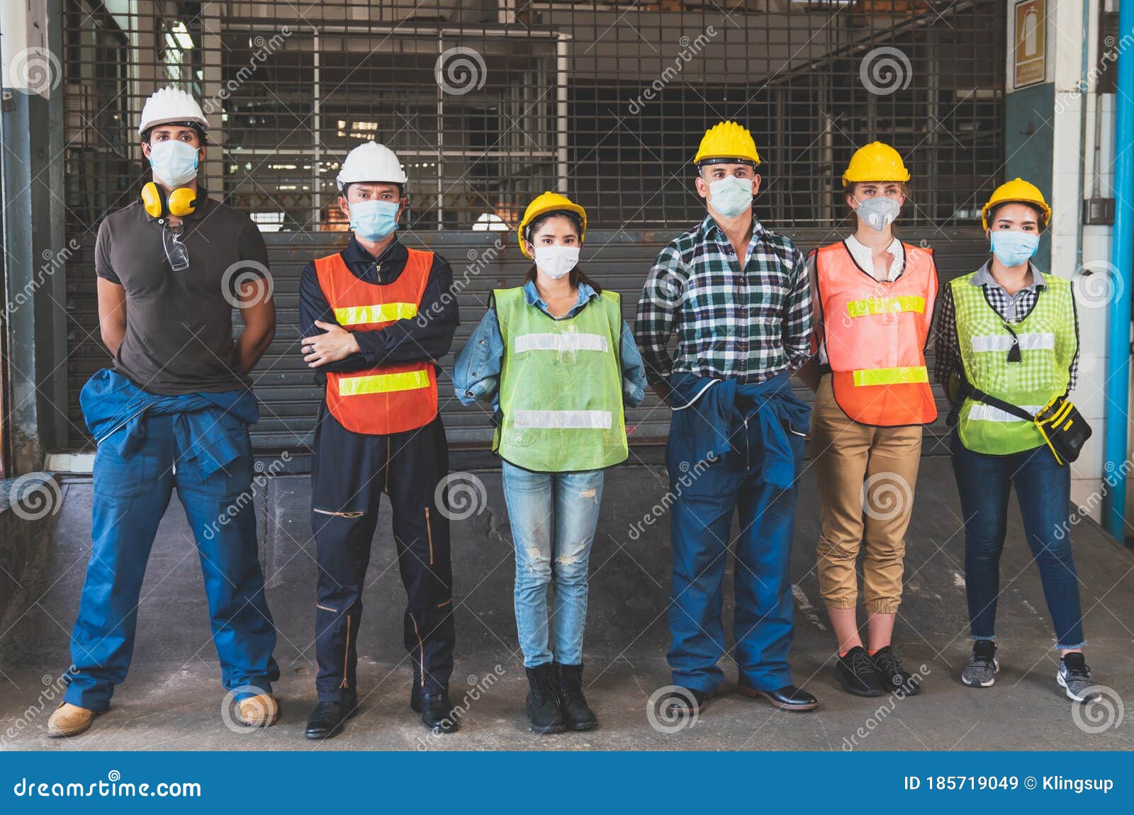 Group of Diverse Team of Workers Wearing Face Mask Standing in Front of ...