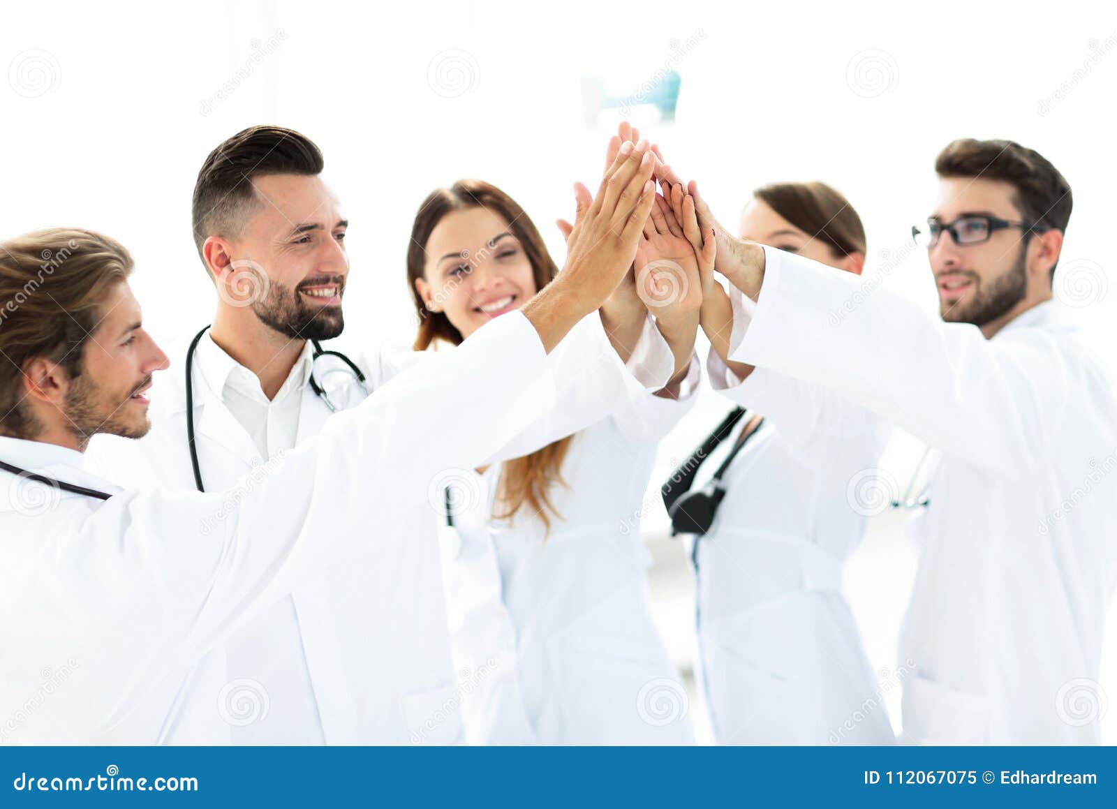 Group of Doctors Giving Each Other a High Five. Stock Image - Image of ...