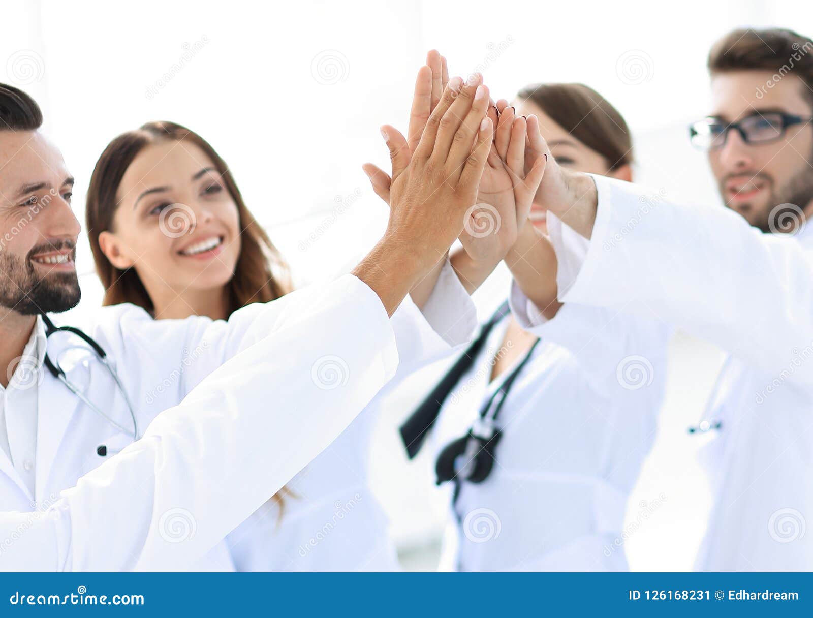 Group of Doctors Giving Each Other a High Five. Stock Image - Image of ...