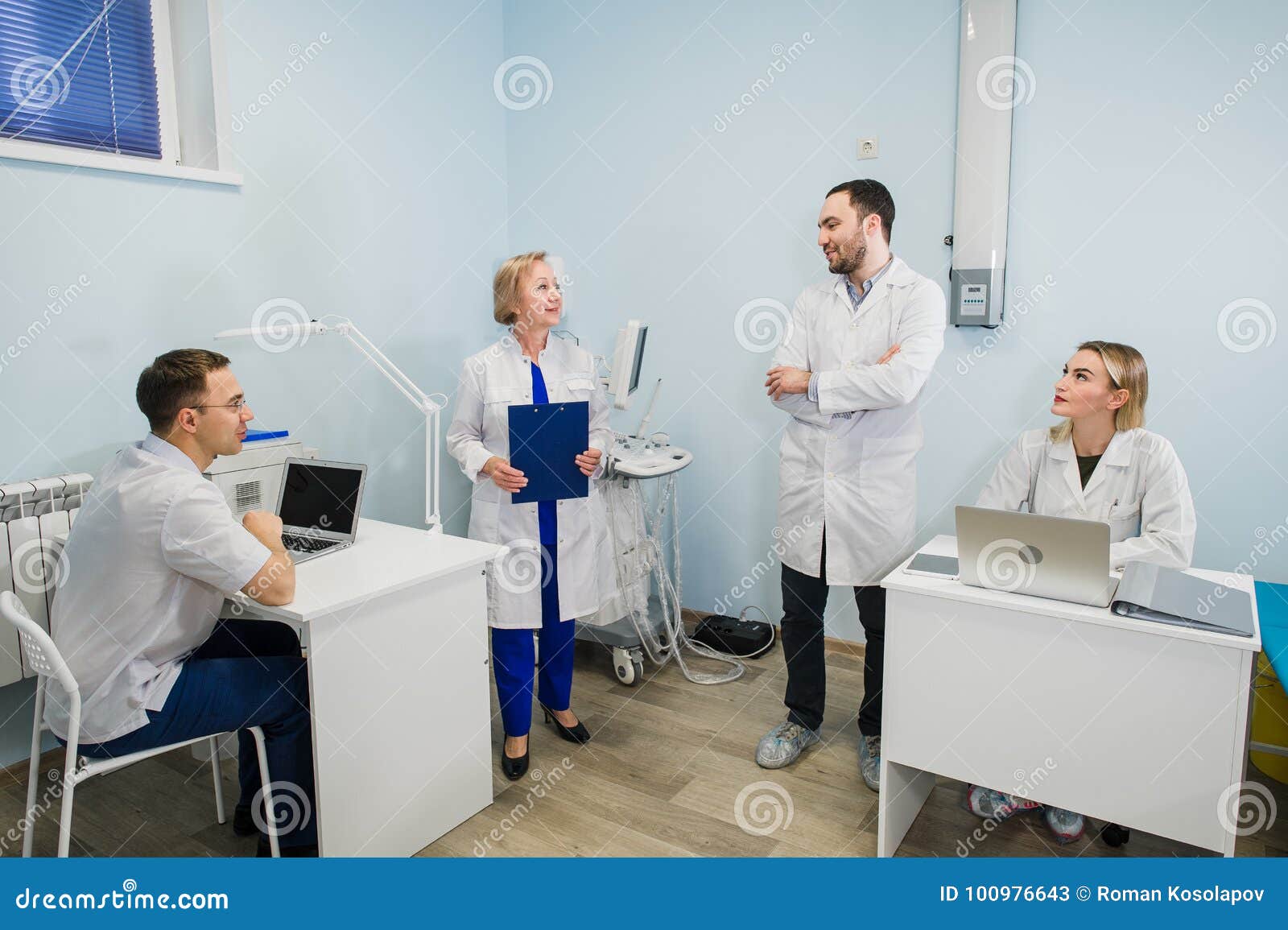 Group of Doctors Involved in Serious Discussion with Medical Records ...