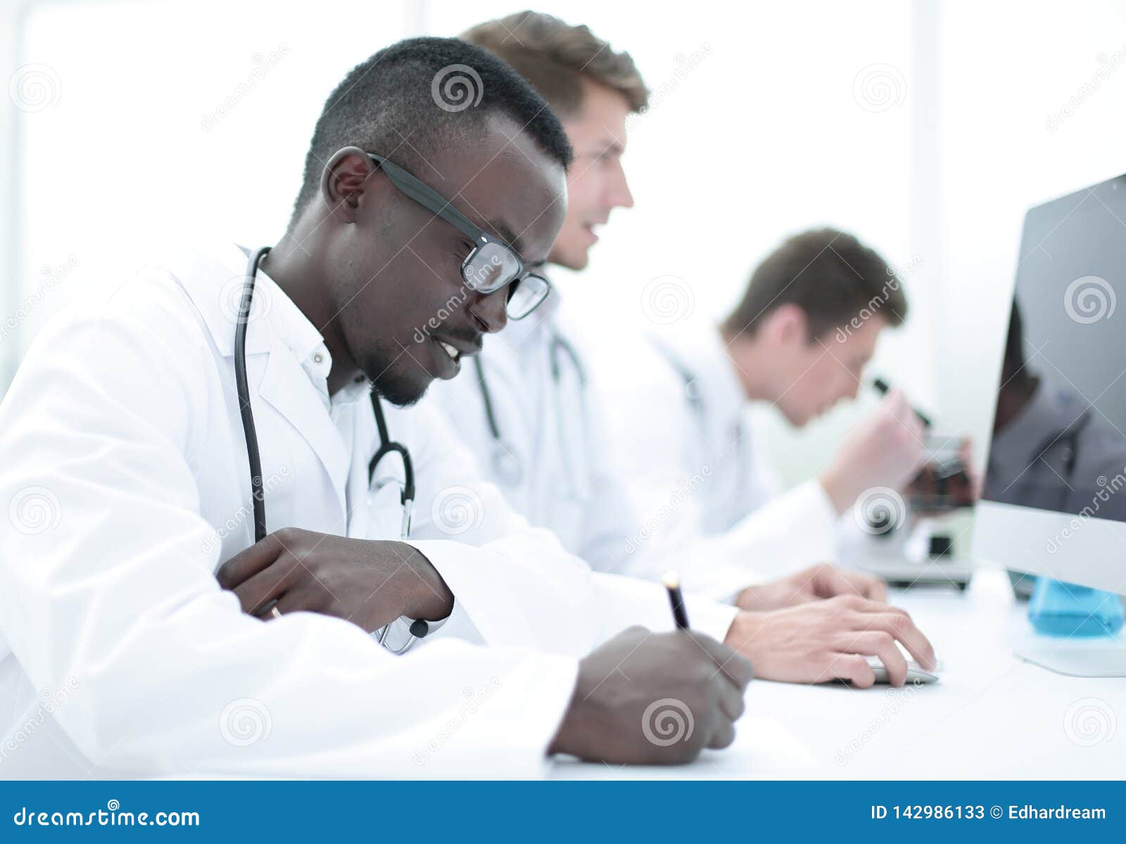 Group of Doctors Sitting in the Laboratory Stock Image - Image of desk ...