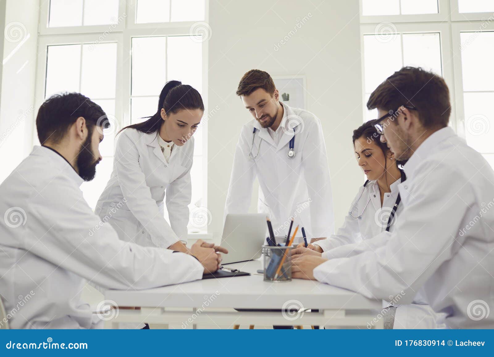 Group of Doctors Talking Sitting at a Table in the Office of the ...