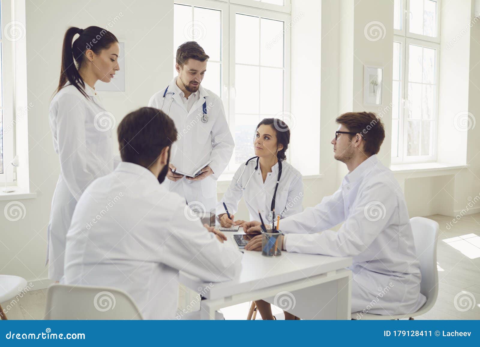 Group of Doctors Talking Sitting at a Table in the Office of the ...