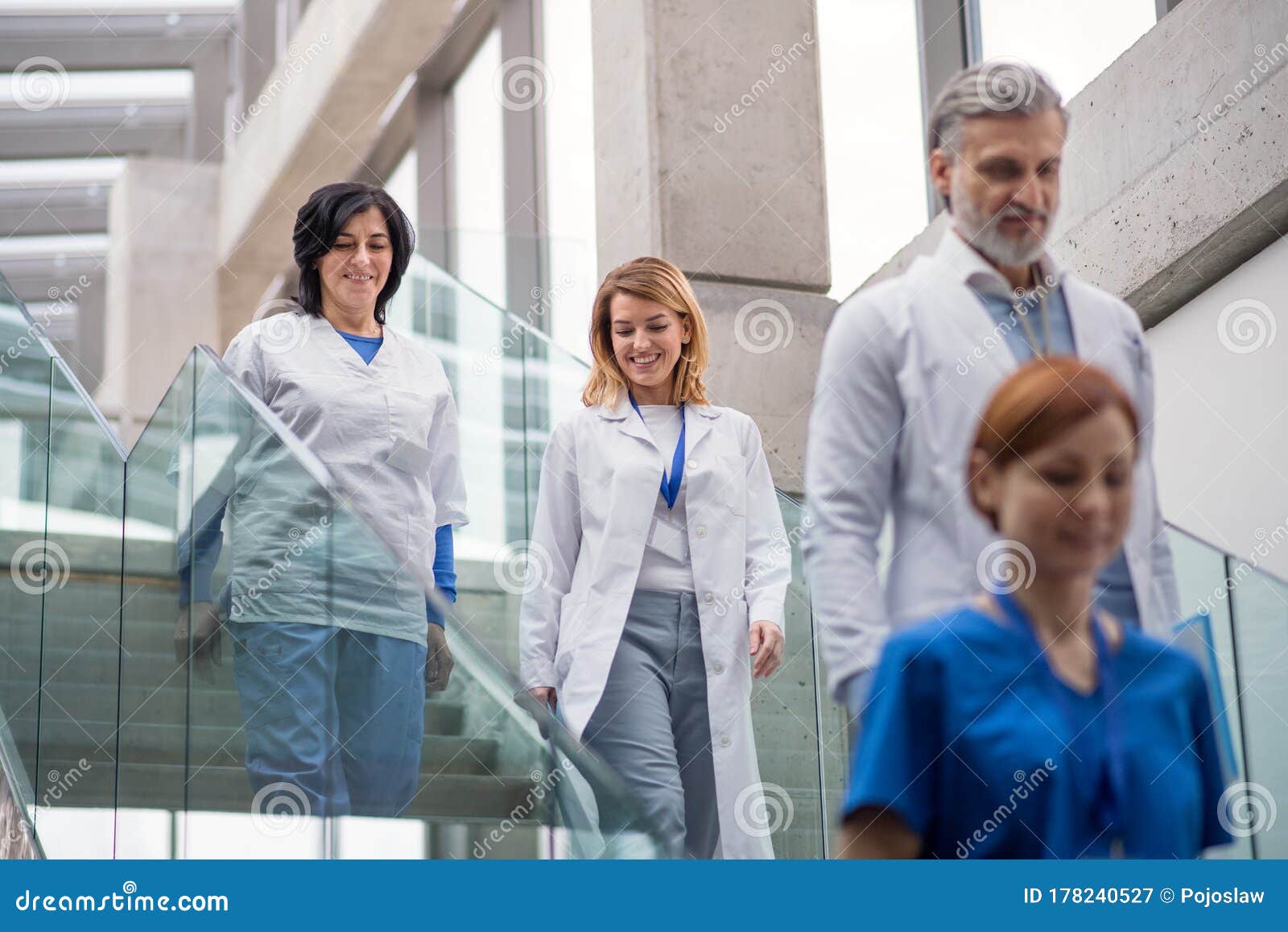 Group of Doctors Walking Down Stairs on Medical Conference. Stock Image ...