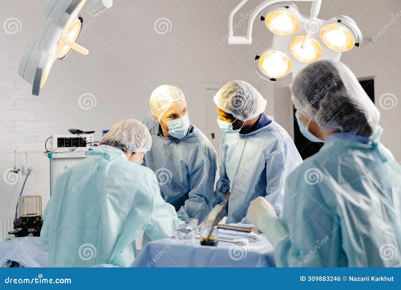 A Group of Doctors Wearing Masks are Standing Together Around a Table ...