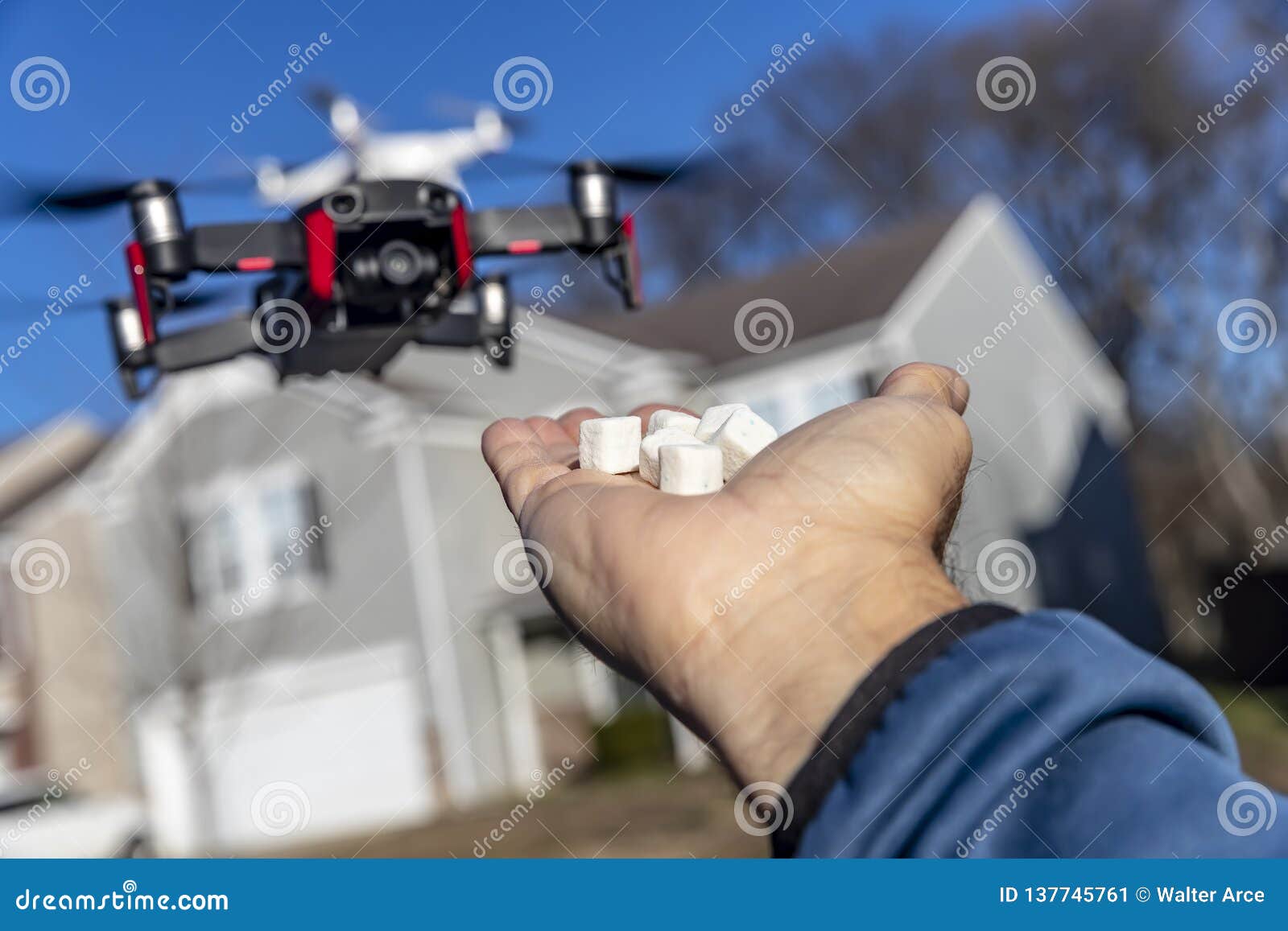 A Group of Drones Fly Together through the Air Against a Blue Sky Stock ...