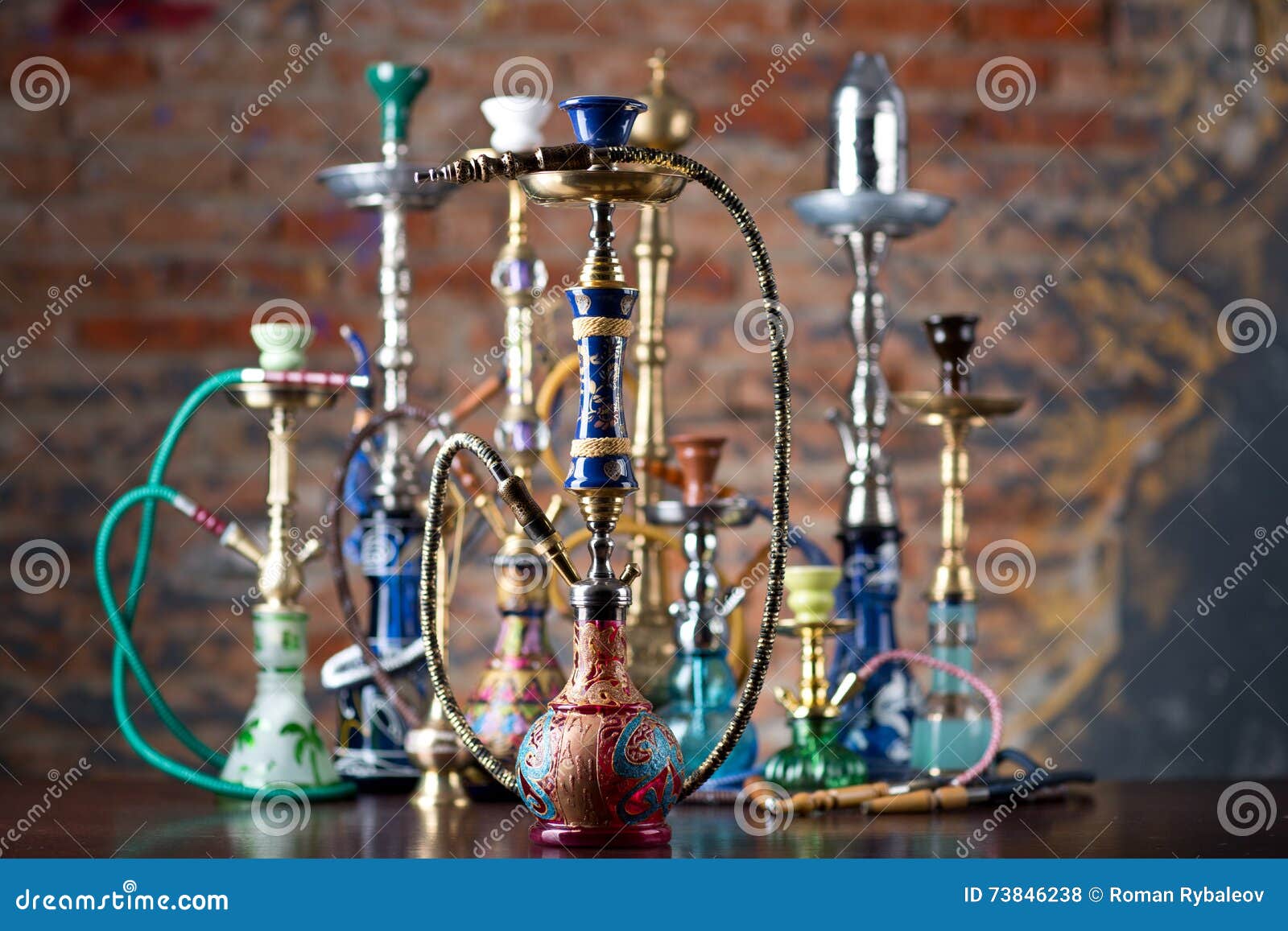 Group of Eastern Hookahs on Wood Table Stock Photo - Image of gold ...