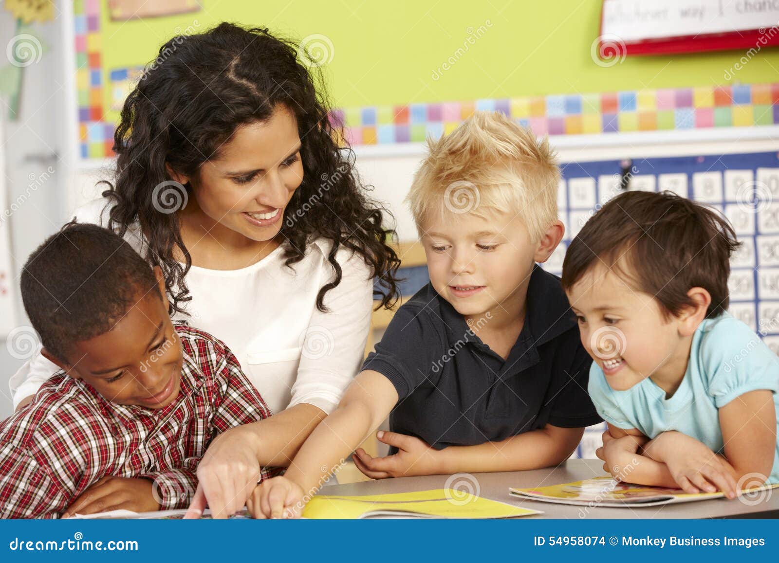 Group of Elementary Age Schoolchildren in Class with Teacher Stock ...