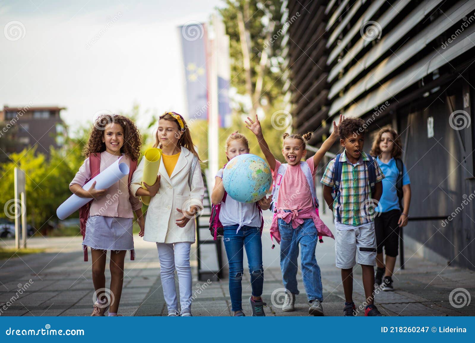 A Group Of Elementary School Kids Rushing Out Of School Royalty-Free ...