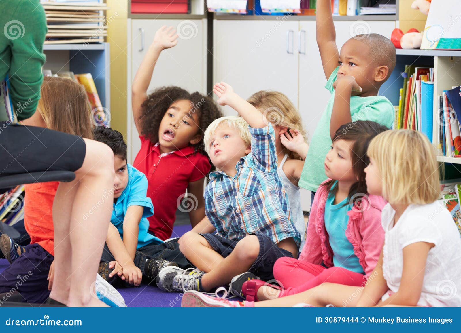 Group of Elementary Pupils in Classroom Answering Question Stock Photo ...