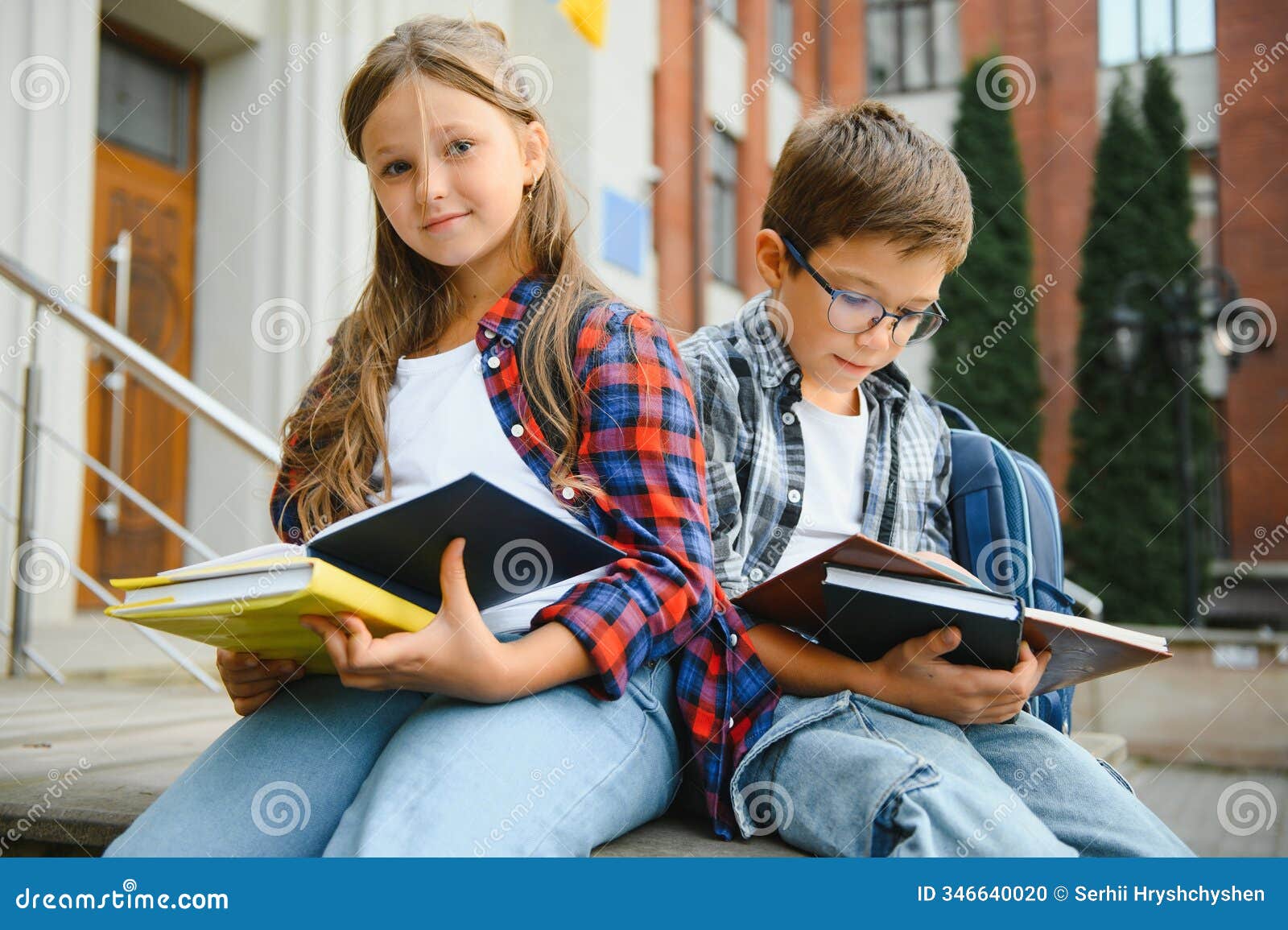 Group of Elementary School Children Reading Books Having an Outdoor ...
