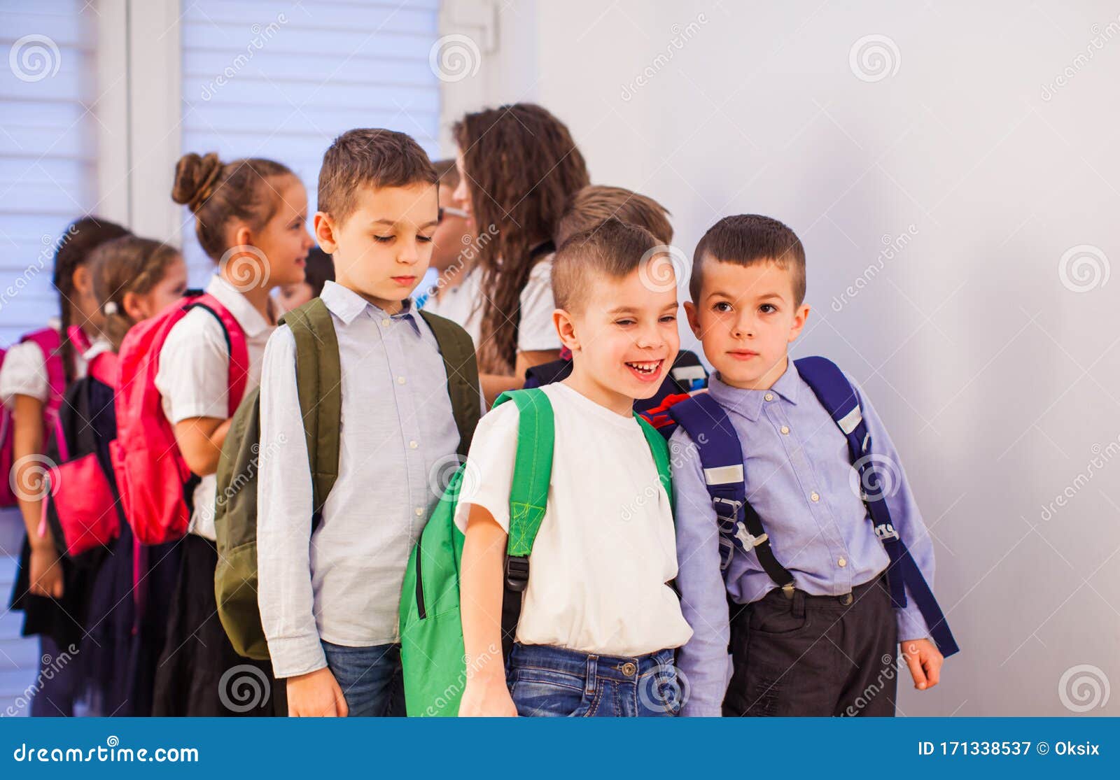 Group of Elementary School Kids with Backpacks in School Corridor. Back ...