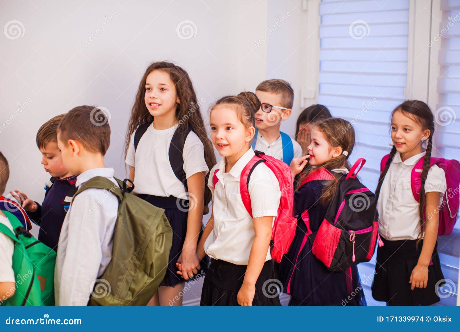 Group of Elementary School Kids with Backpacks in School Corridor. Back ...