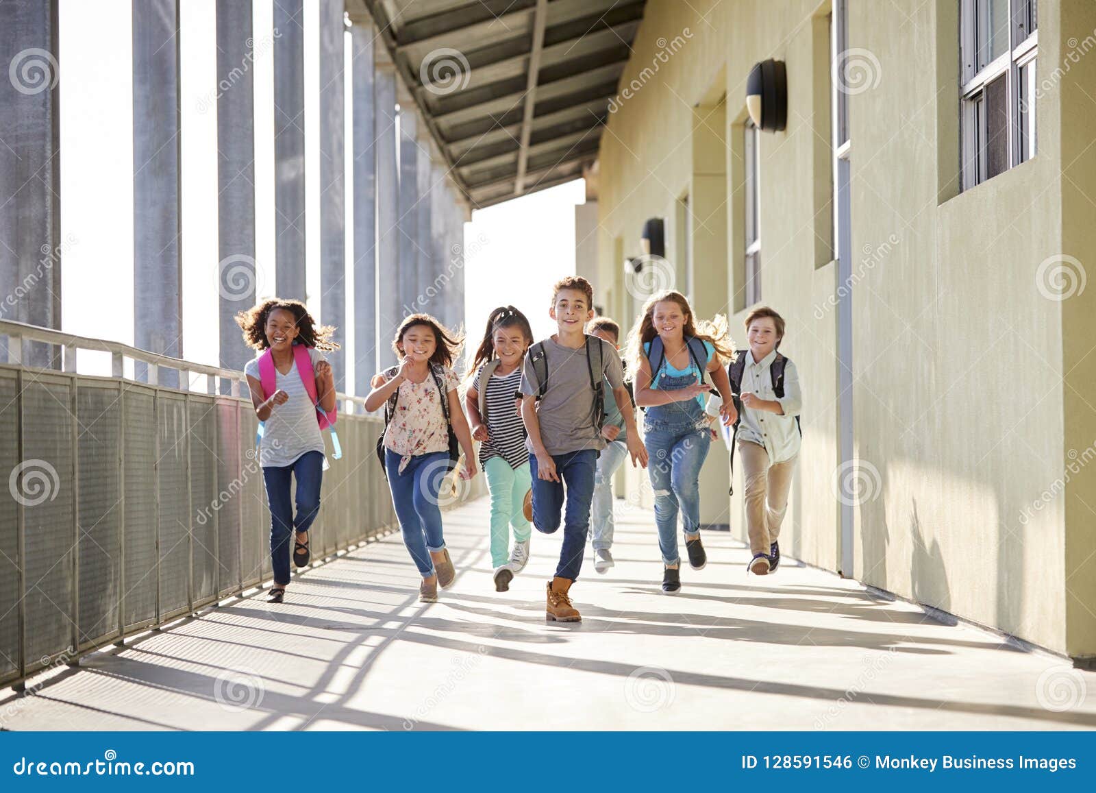 Group of Elementary School Kids Running in a School Corridor Stock ...