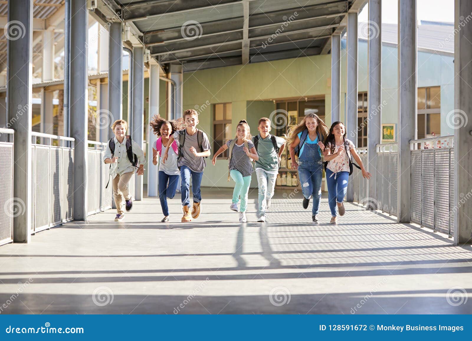 Group of Elementary School Kids Running in a School Corridor Stock ...