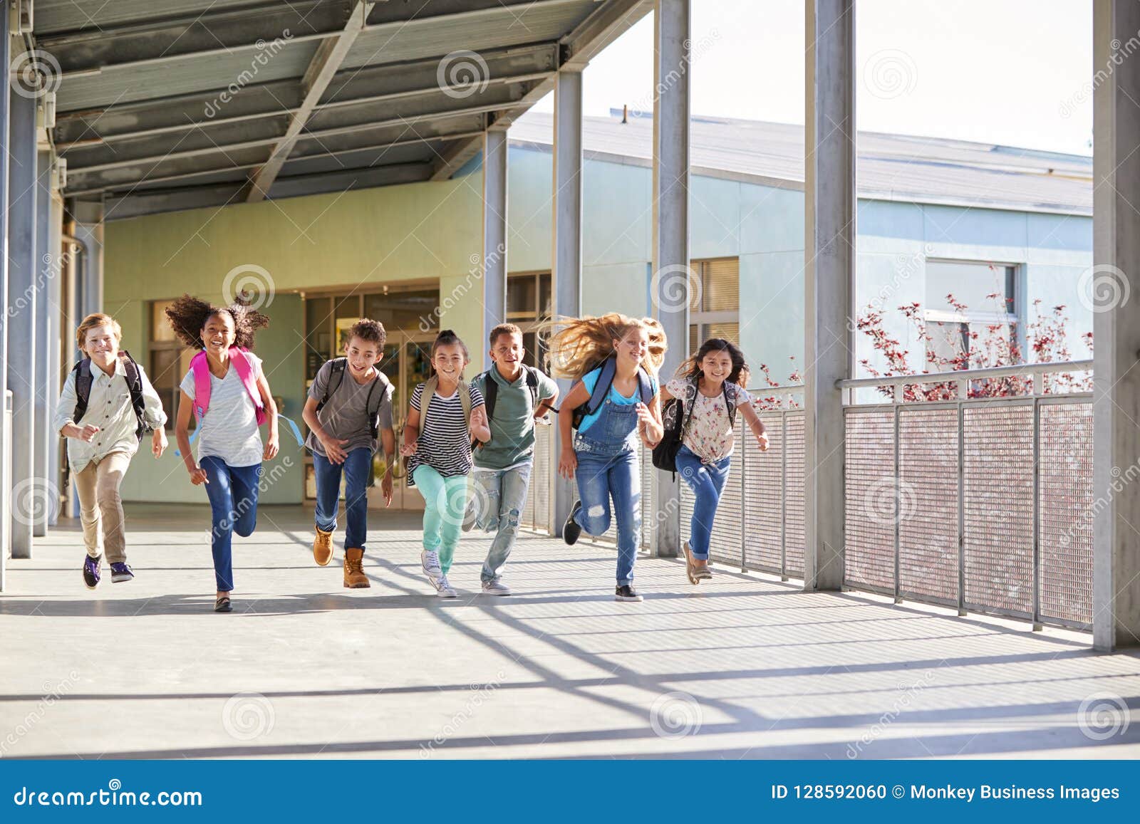 Group of Elementary School Kids Running in a School Corridor Stock ...
