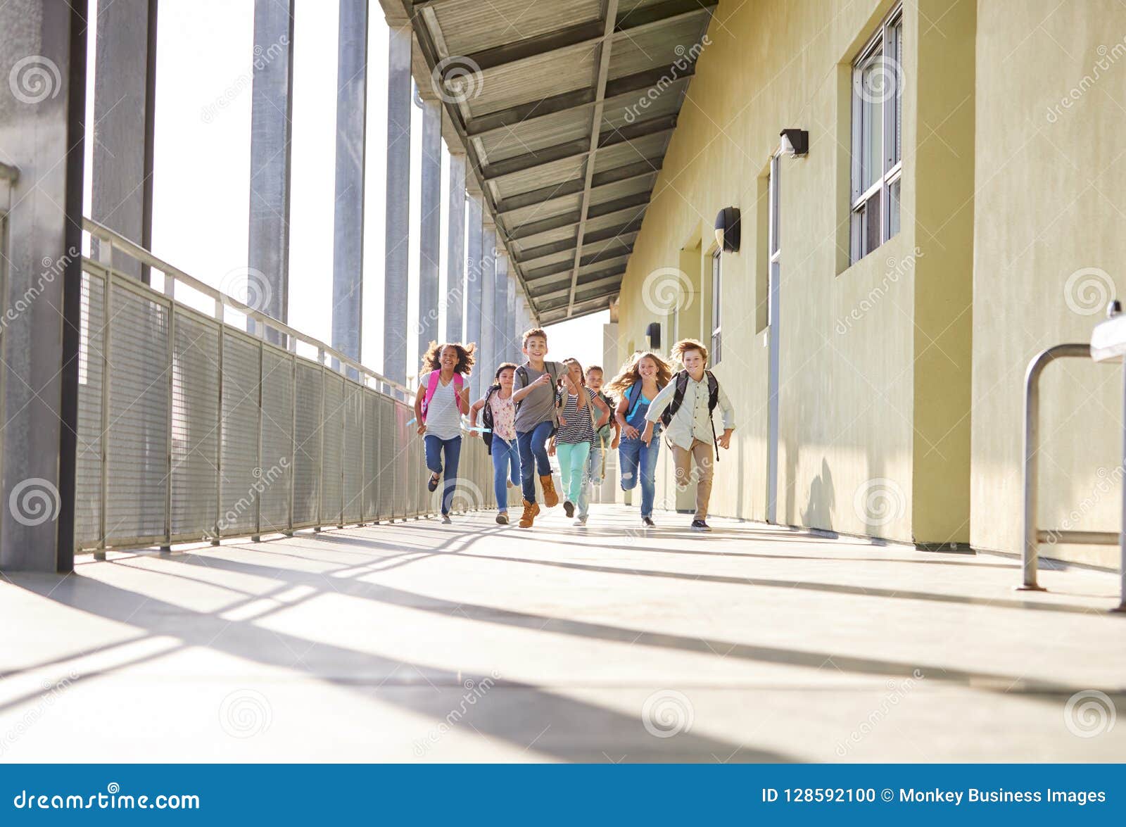 Group of Elementary School Kids Running in a School Corridor Stock ...