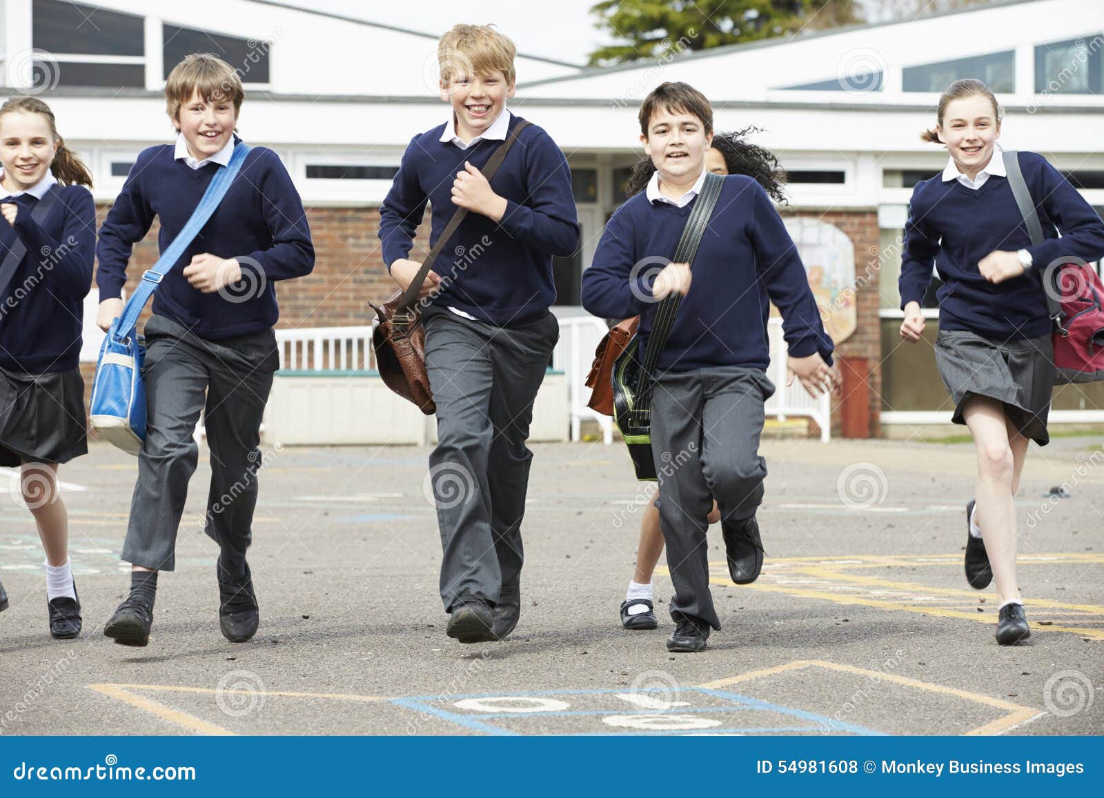 Group of Elementary School Pupils Running in Playground Stock Photo ...