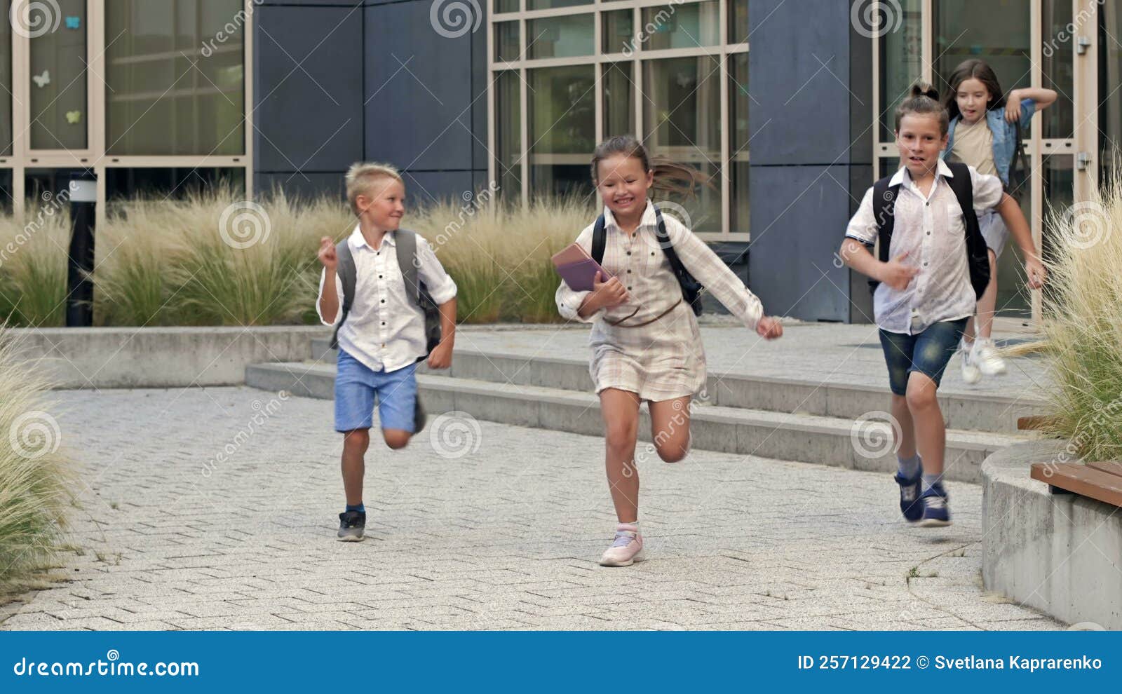 Group of Elementary School Students Joyfully Run Out of the School ...