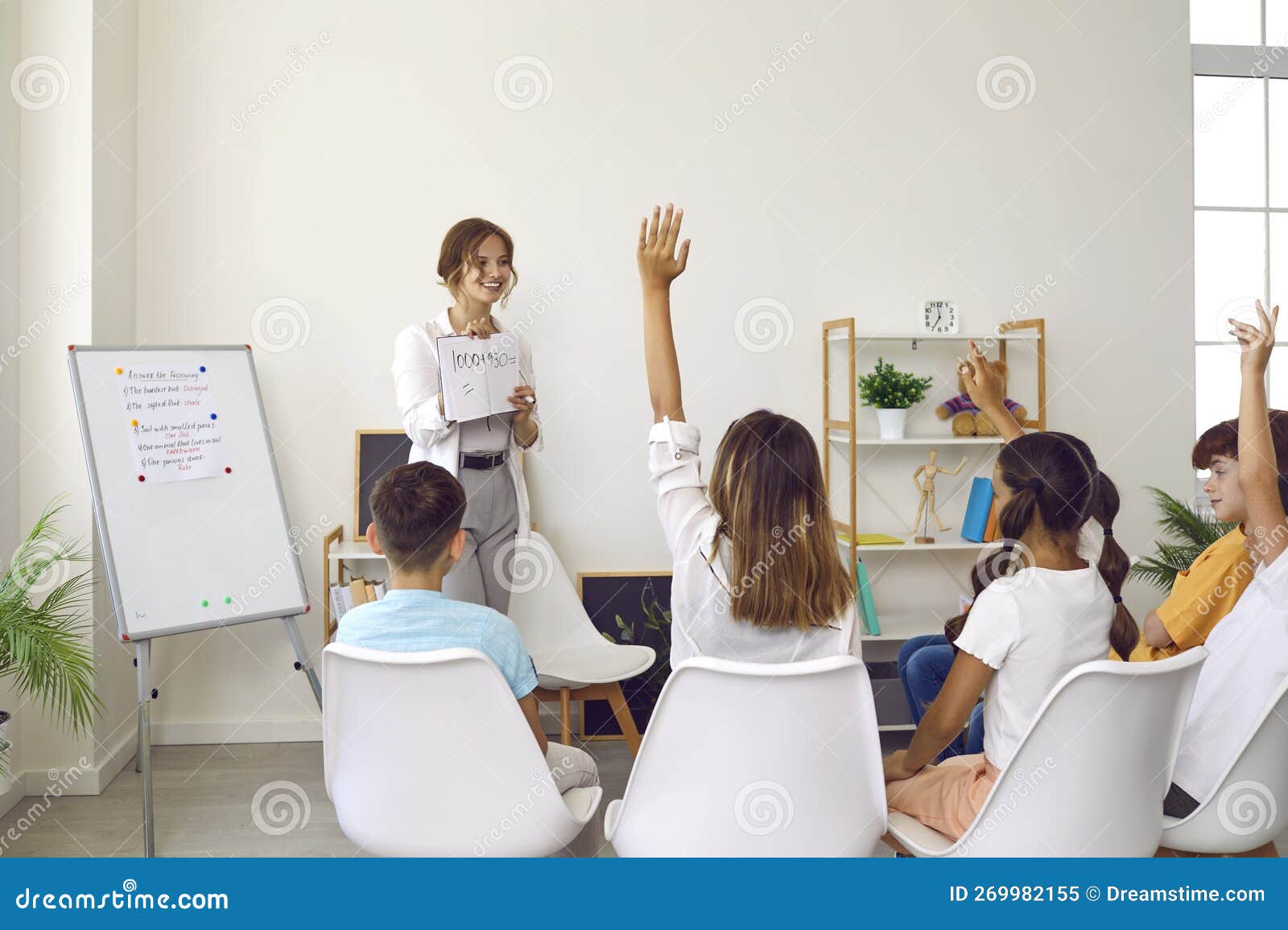 Group of Elementary School Students Raising Hands To Answer Question in ...