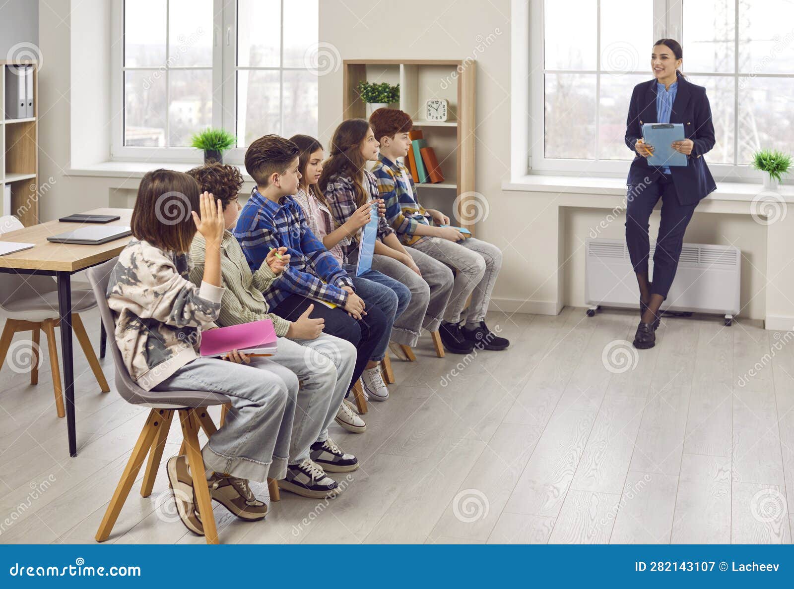 Group of Elementary School Students and Their Teacher Having a Class in ...