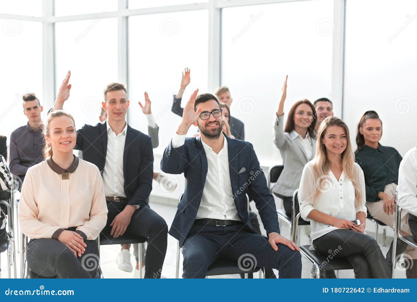 Group Of Employees Asking Questions During A Business Meeting Stock