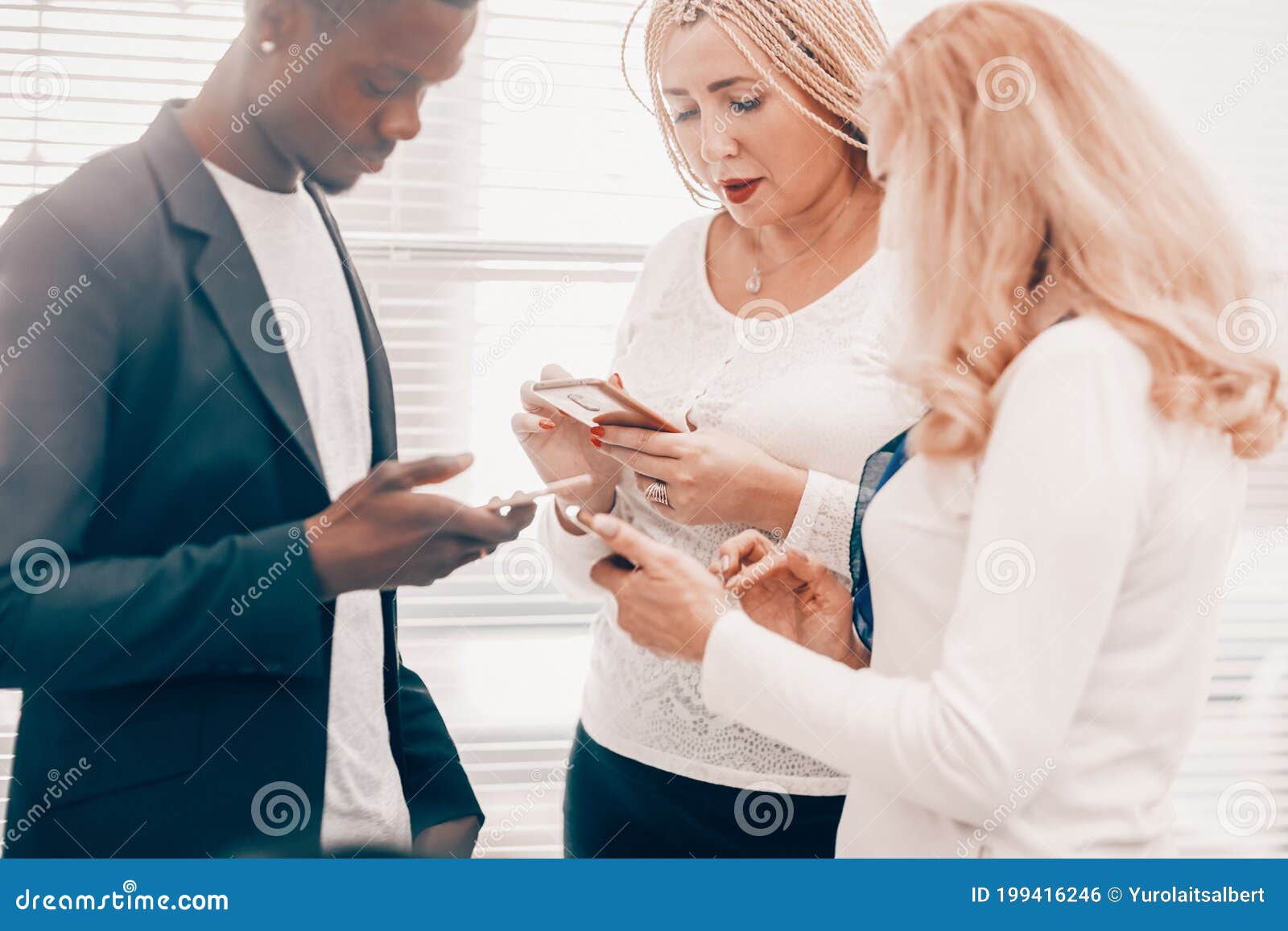 Group of Employees with Interest Watching the Video on Their Smartphone ...