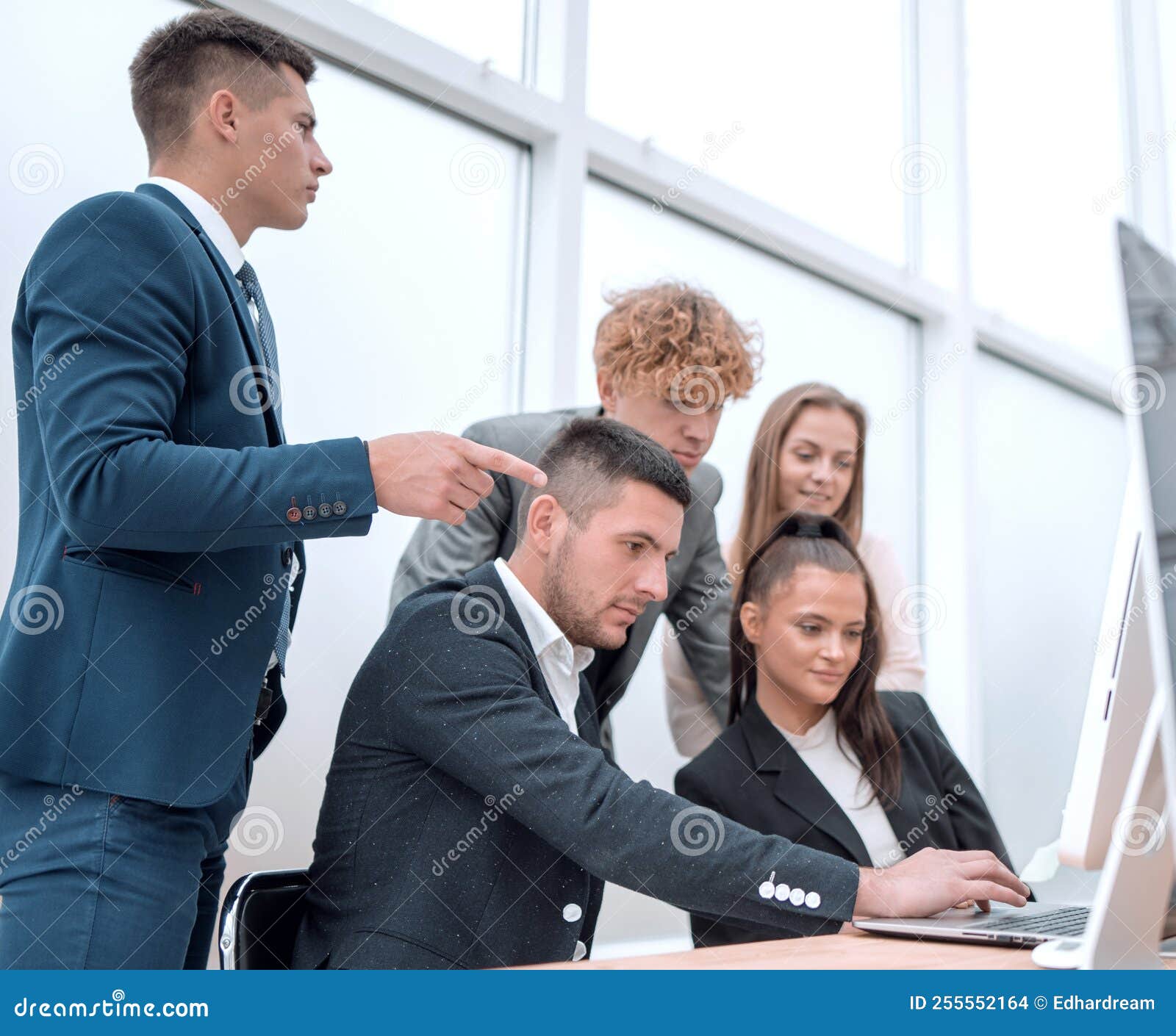Group of Employees Reading Information on a Computer Screen Stock Photo ...