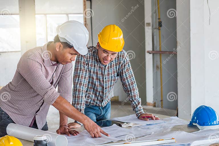 Group of Engineer Checking the Blueprint on the Table and Talking about ...