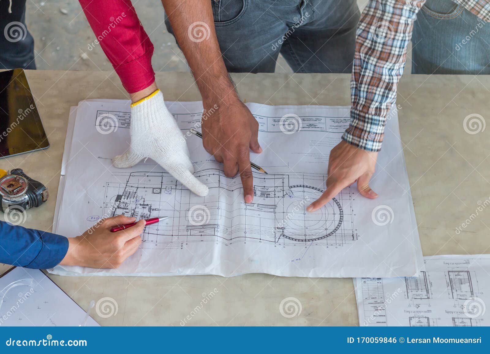 Group of Engineer Checking the Blueprint on Table and Talking about ...