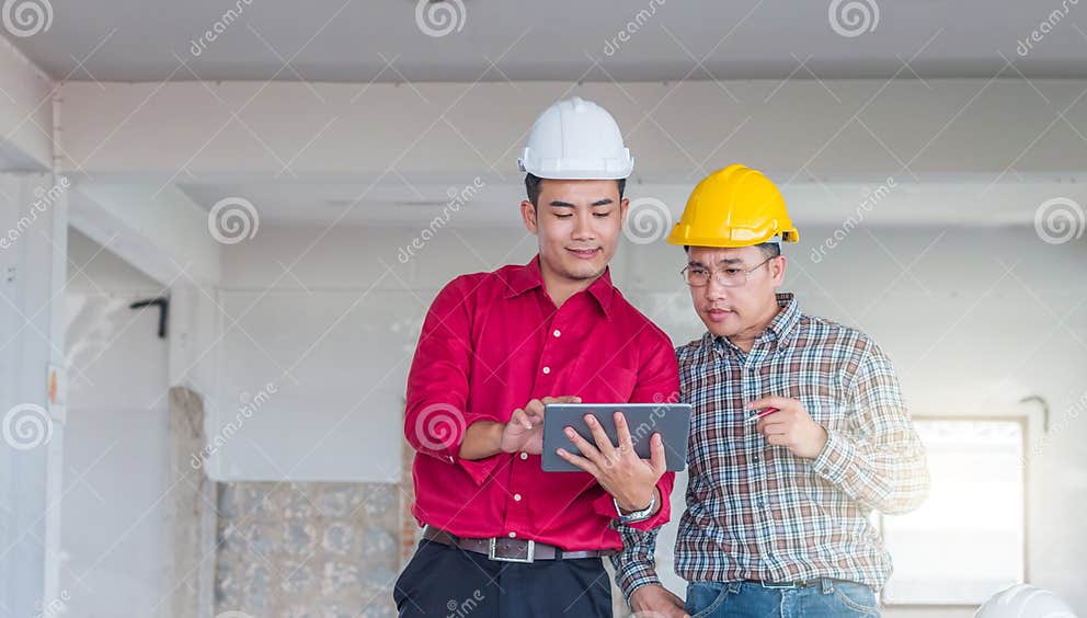 Group of Engineer Checking the Blueprint on the Table and Talking about ...