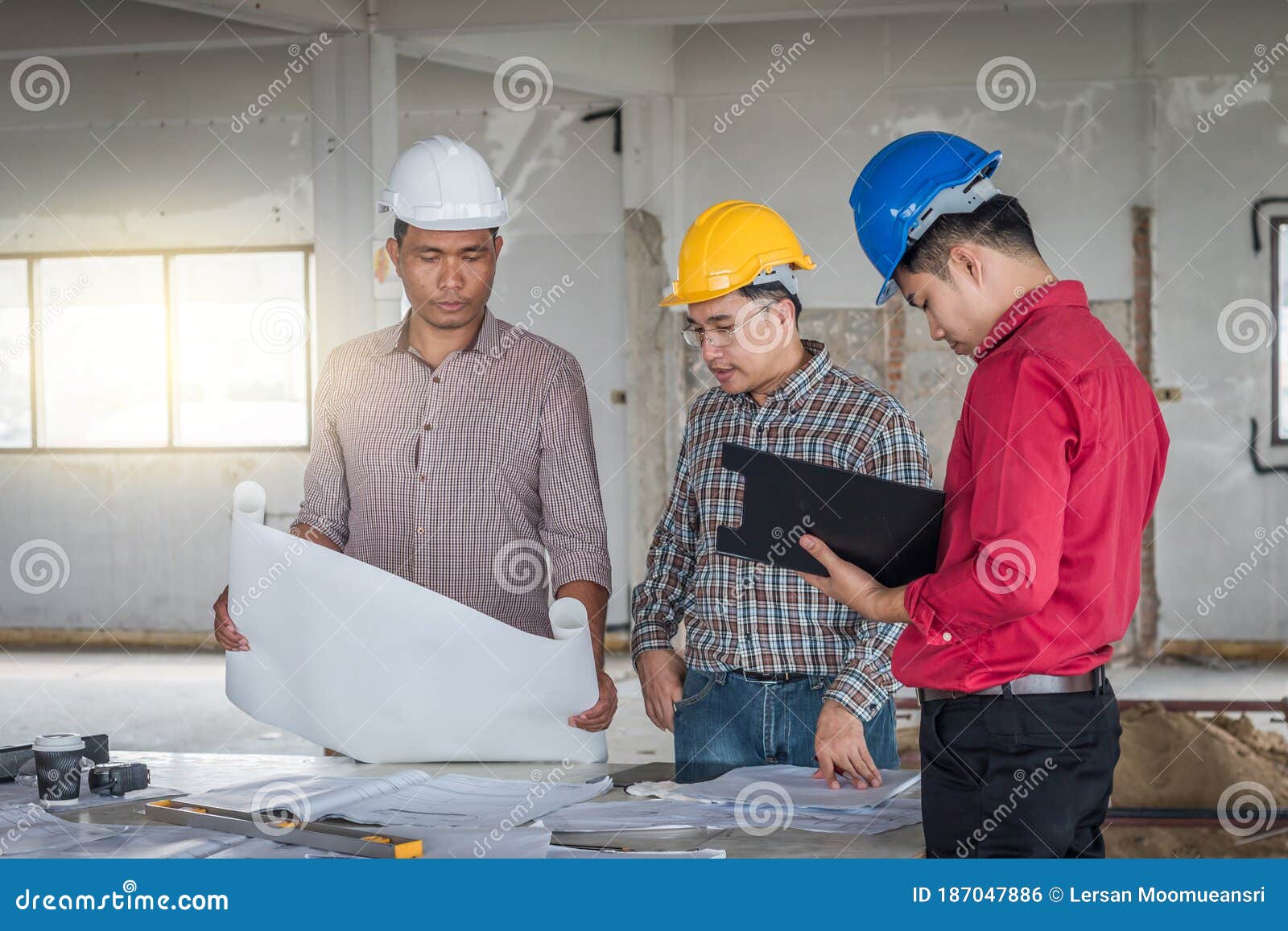 Group of Engineer Checking the Blueprint on the Table and Talking about ...