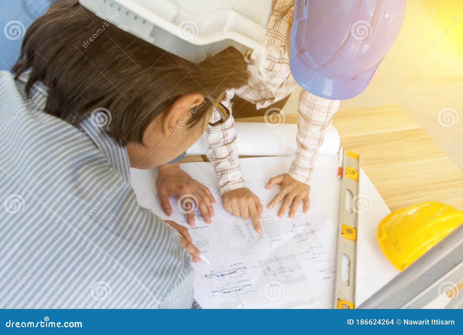 A Group of Engineers are Looking at a Blueprint for Construction Stock ...