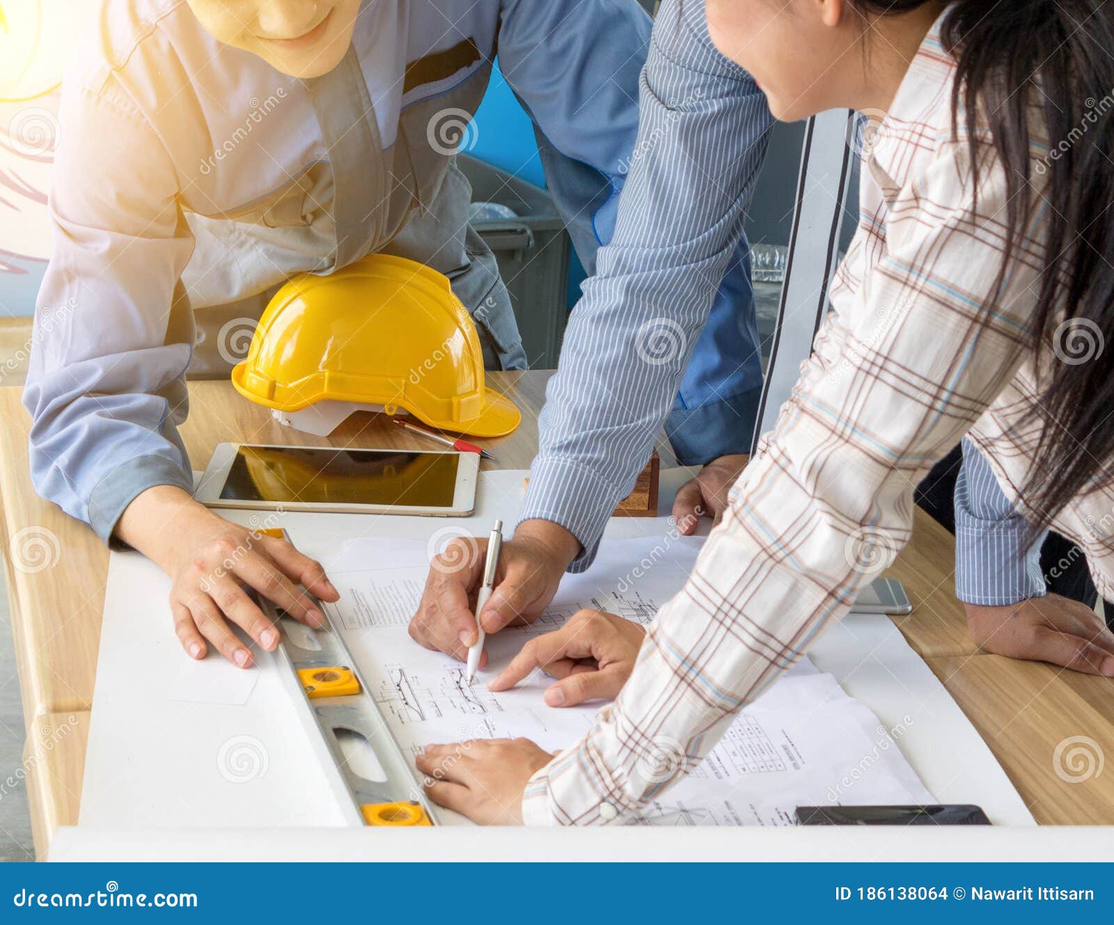 A Group of Engineers are Looking at a Blueprint for Construction Stock ...