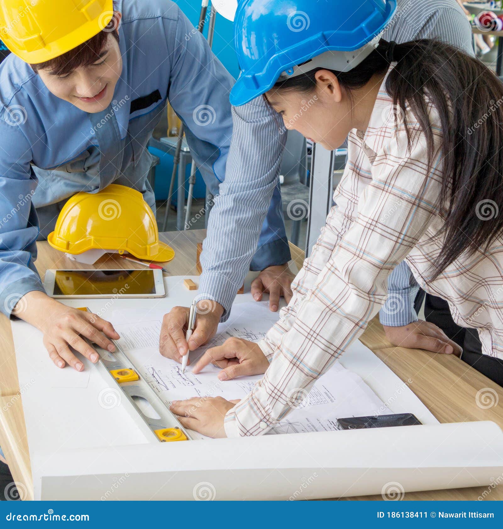 A Group of Engineers are Looking at a Blueprint for Construction Stock ...